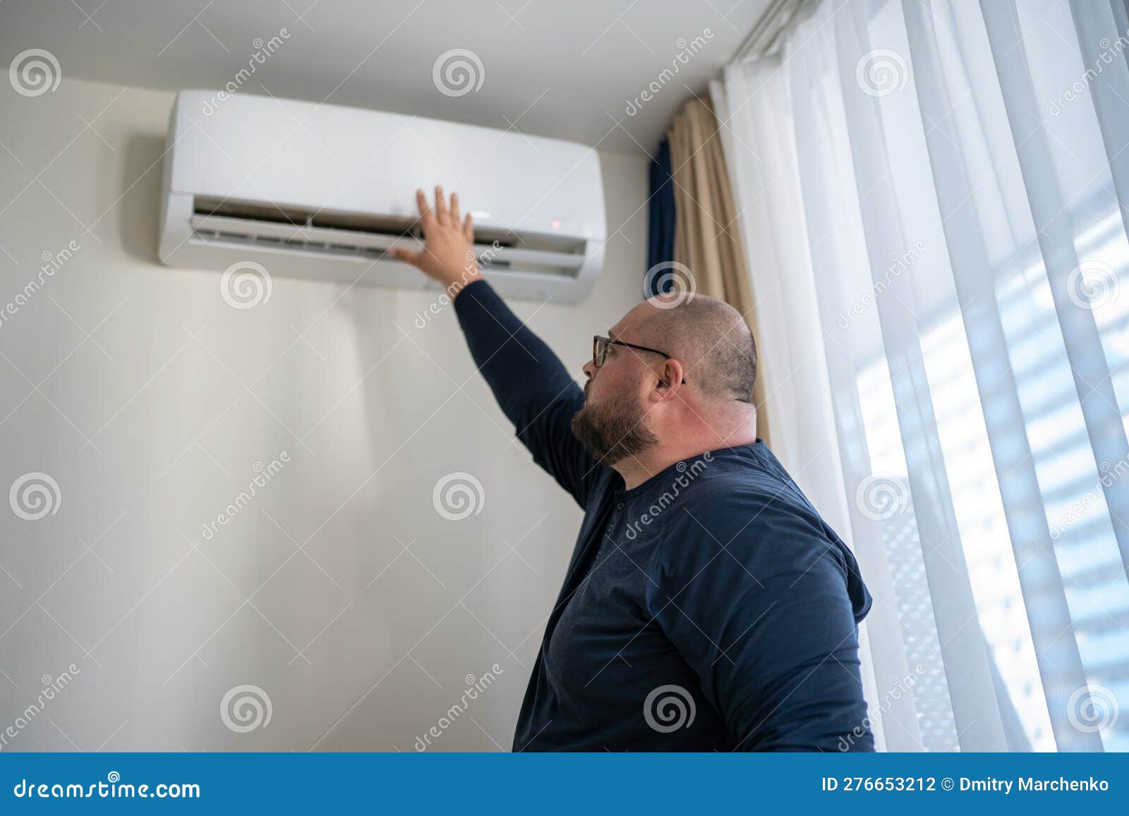 Man Checking Working Air Conditioner Touching Air by Hand in Summer Hot ...
