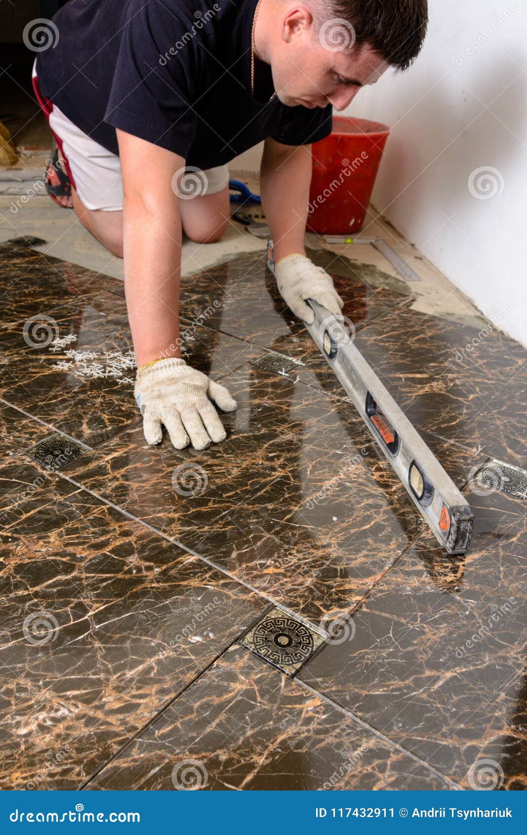 The Man Checks the Surface of the Tile Using the Level Stock Image ...