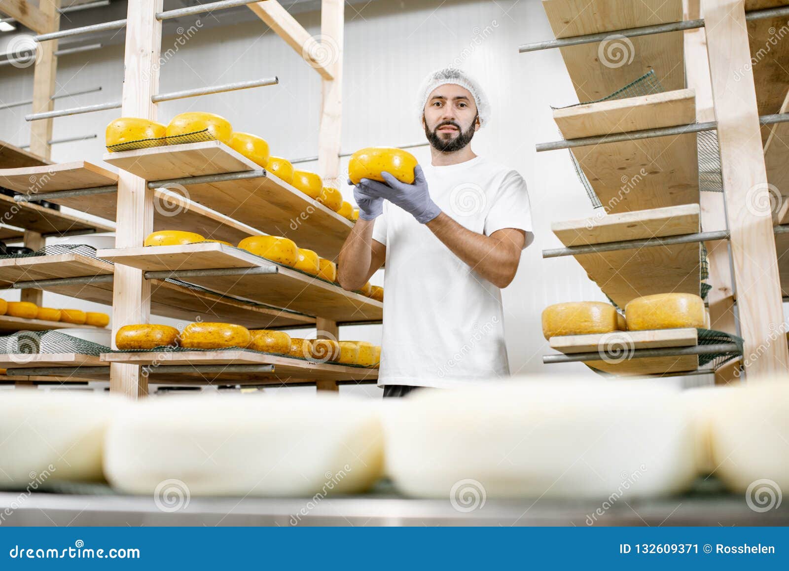 Man with Cheese Wheels at the Storage Stock Image - Image of factory ...