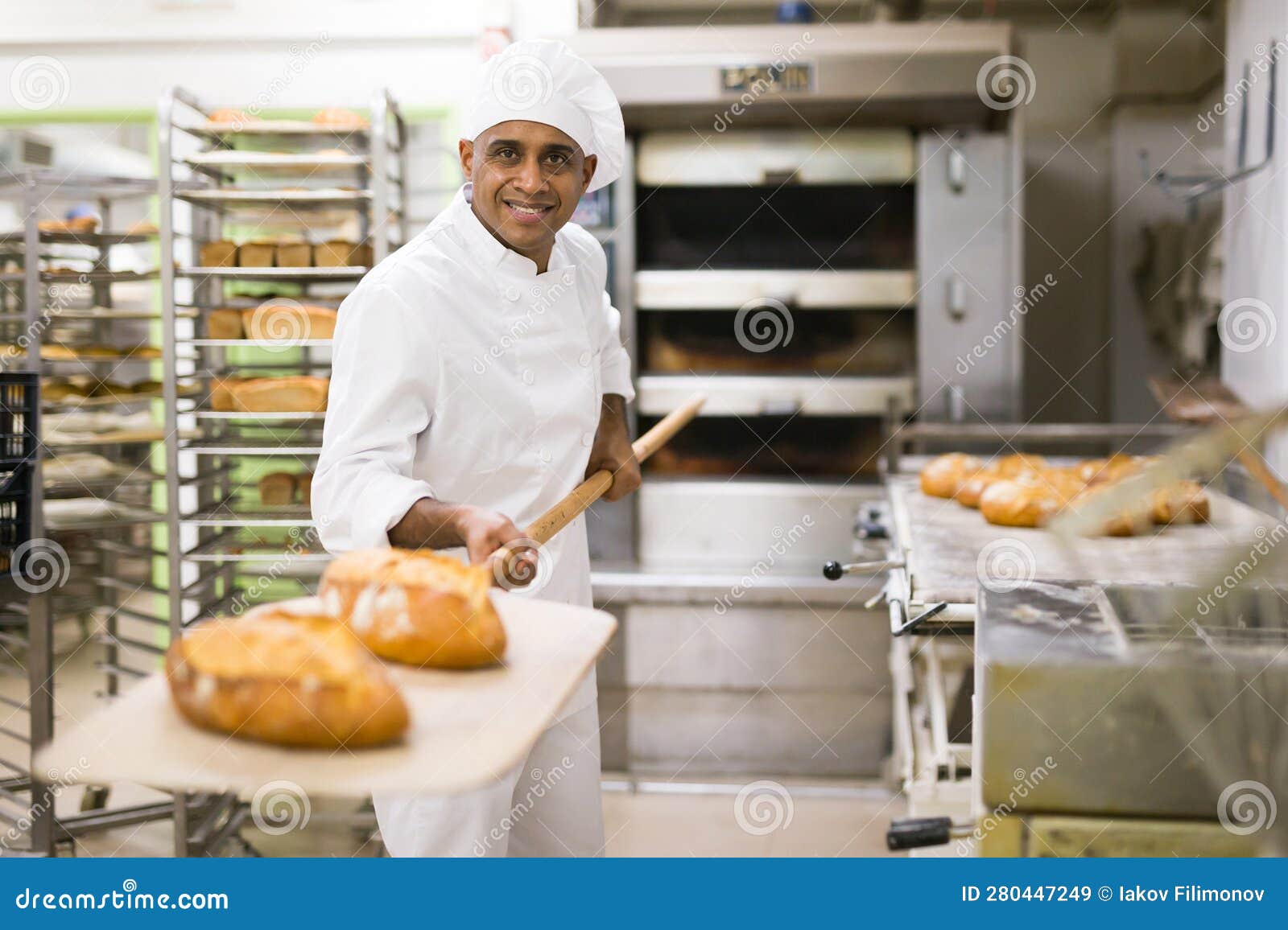 Man in Chefs Uniform with Bread on Shovel in Bakery Stock Image - Image ...