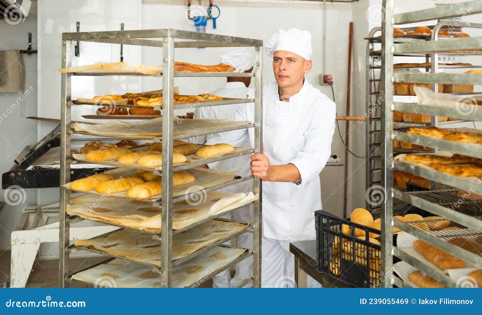 Male Baker Rolling Cart with Bread in Kitchen Stock Image - Image of ...