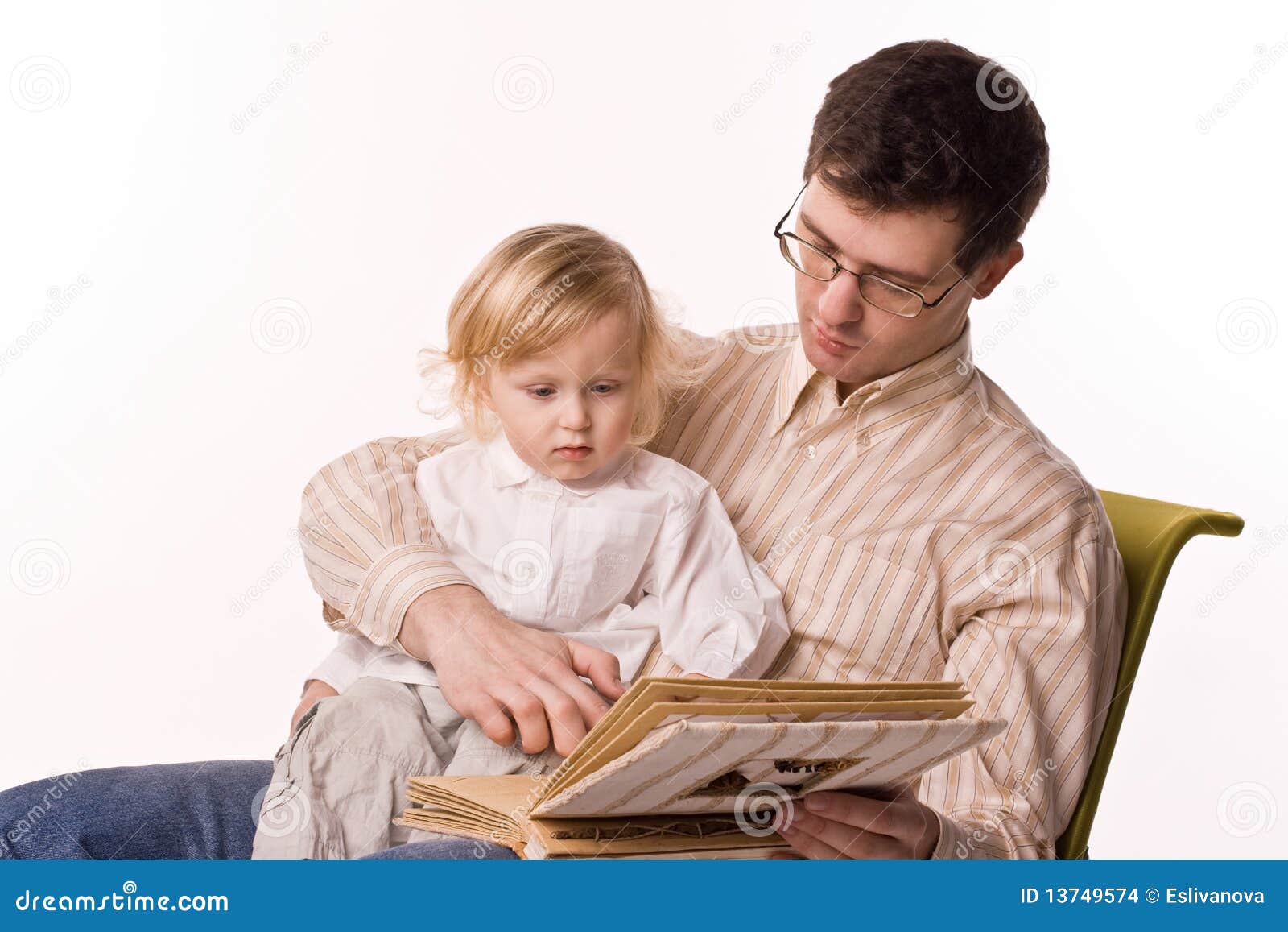 Man and child with book stock photo. Image of sitting - 13749574