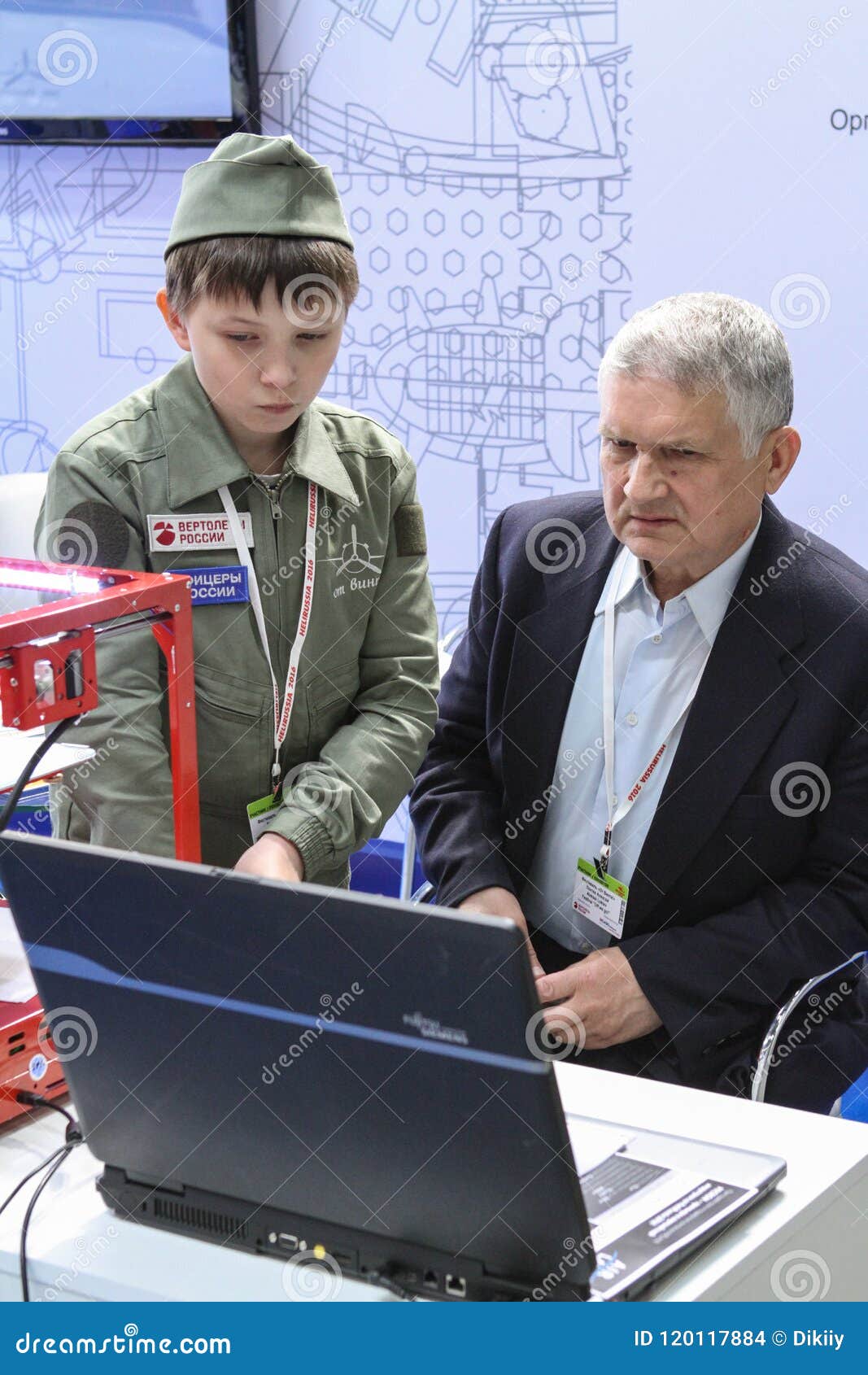A Man and a Child are Studying a Program for Working on a 3D Printer ...