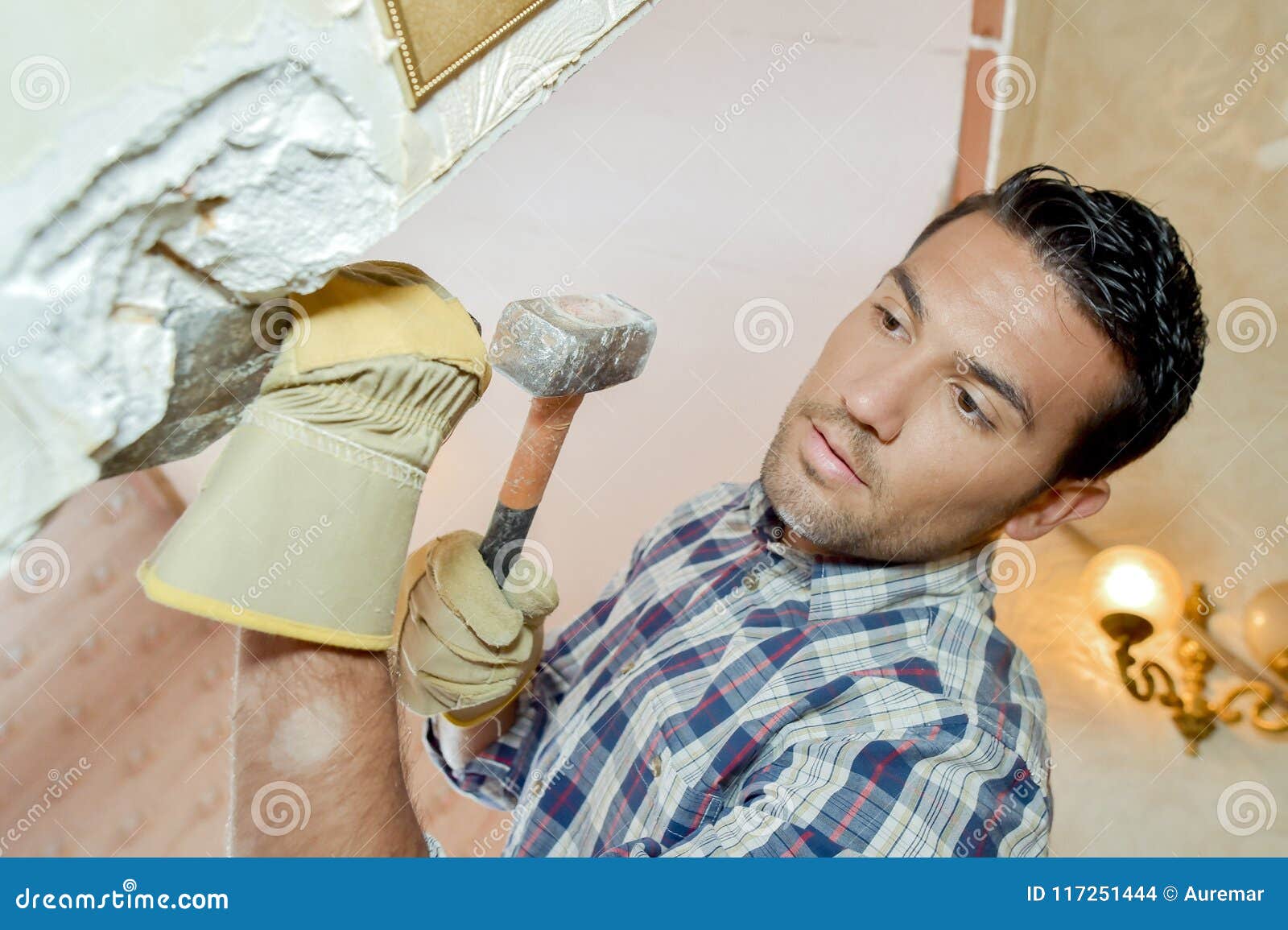 Man chiseling at wall stock photo. Image of builder - 117251444