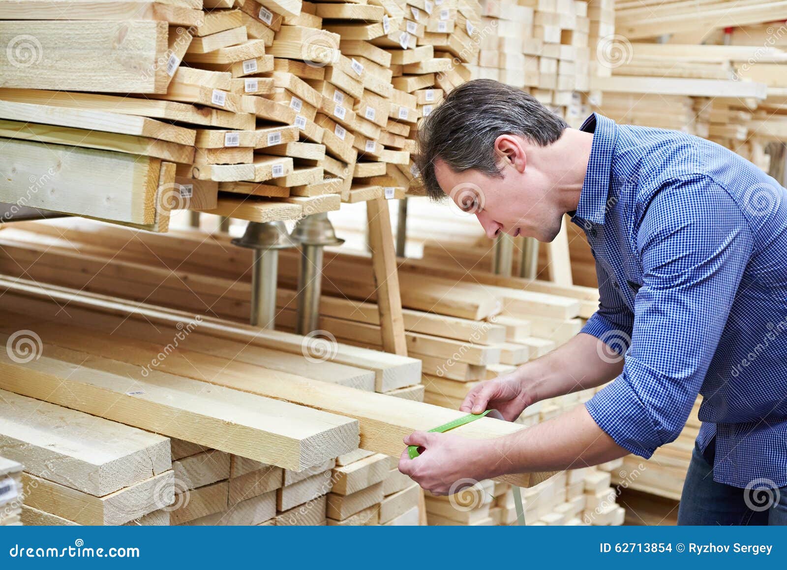 Man Chooses Boards for the Construction in Store Stock Photo - Image of ...