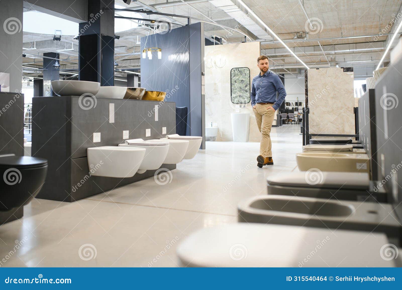 Man Chooses Ceramic Toilet Bowl in a Construction Supermarket Stock ...
