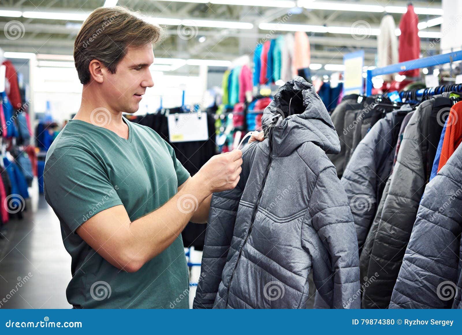 Man Chooses Winter Jacket in Store Stock Photo - Image of choice ...