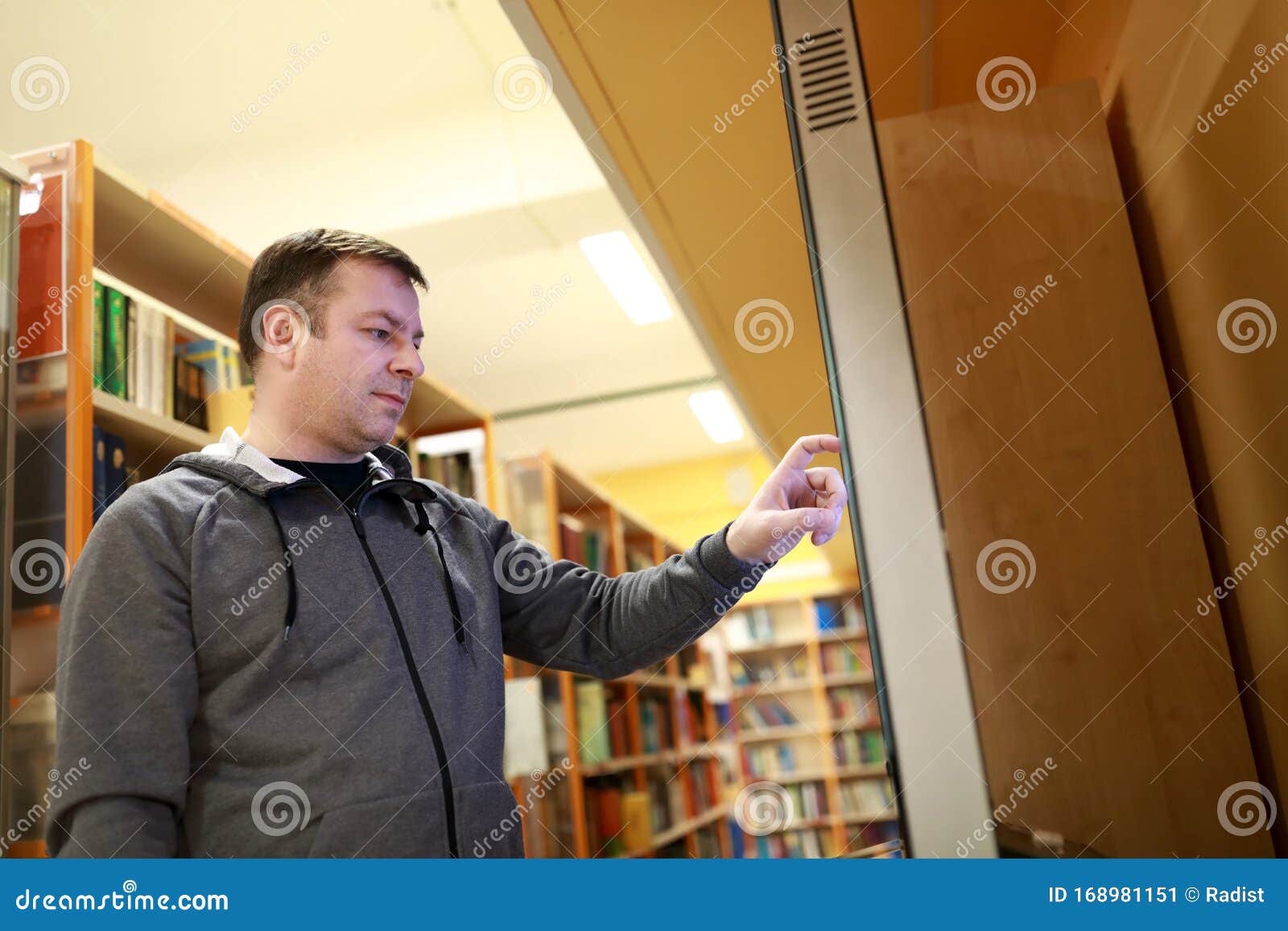Man Choosing Book Using Touchscreen Stock Image - Image of casual ...