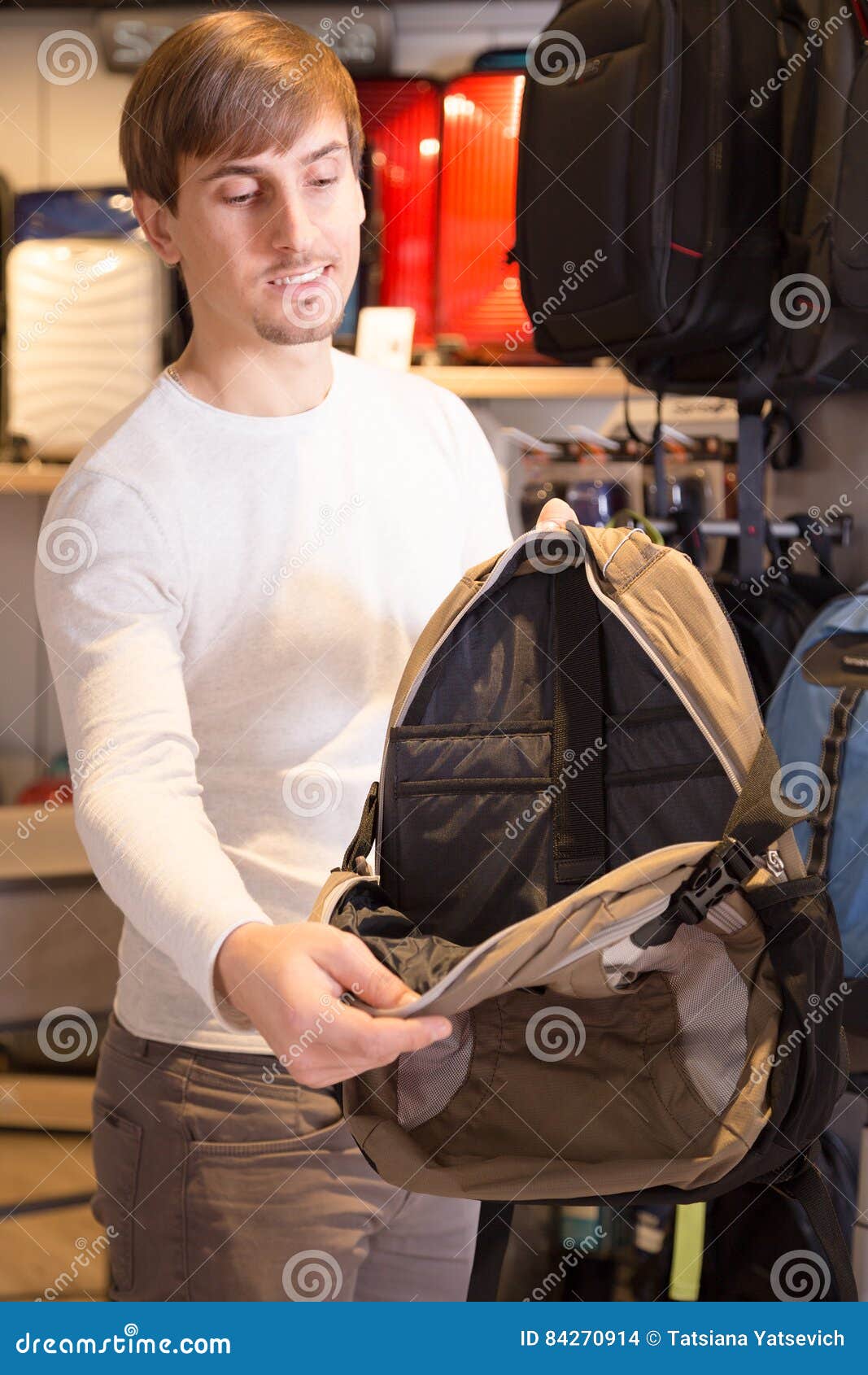 Man Choosing Knapsack among Assortment in Store Stock Photo - Image of ...