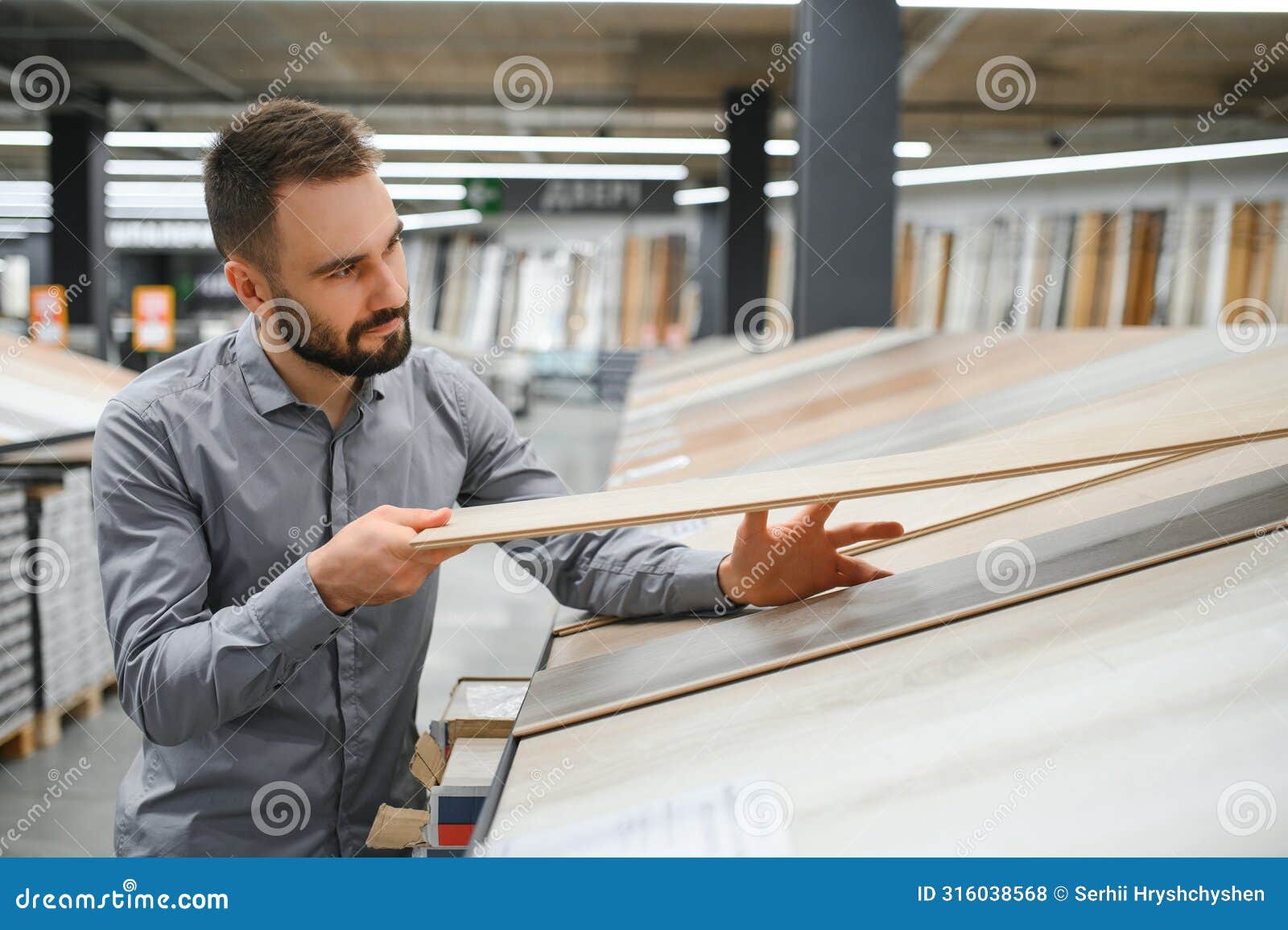 Man Choosing Laminate Samples in Hardware Store Stock Photo - Image of ...
