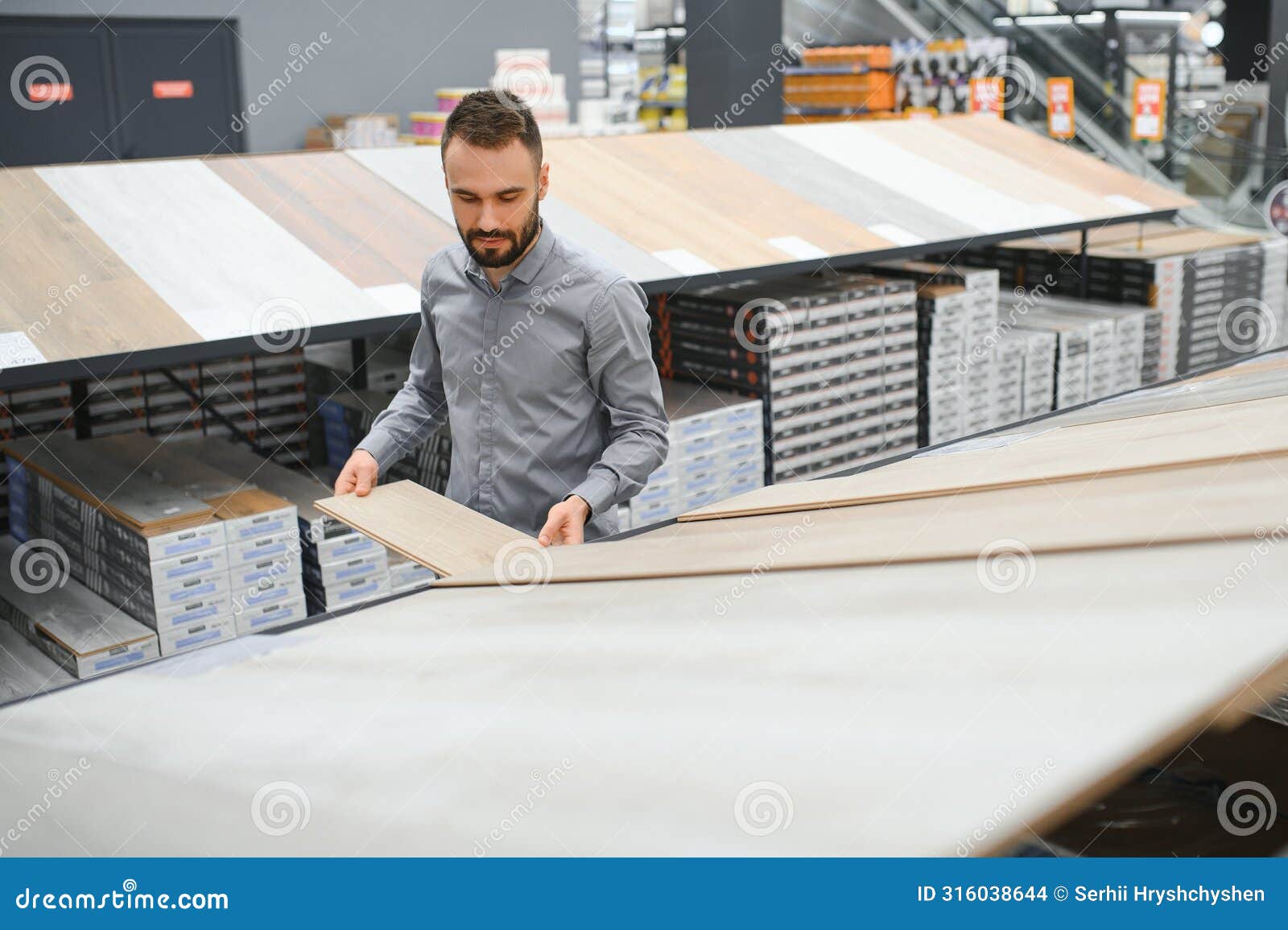 Man Choosing Laminate Samples in Hardware Store Stock Photo - Image of ...