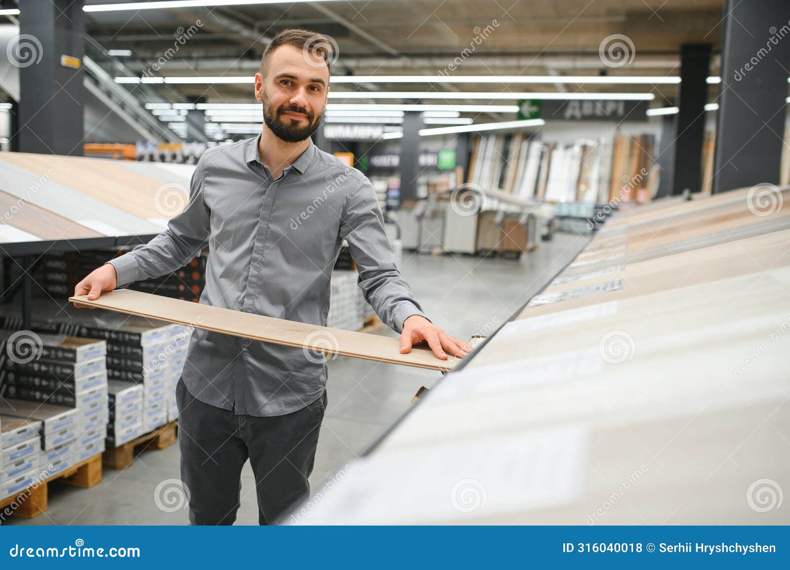 Man Choosing Laminate Samples in Hardware Store Stock Photo - Image of ...