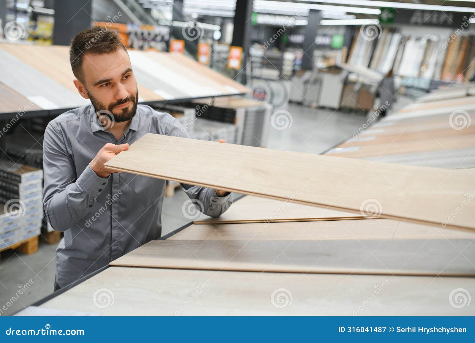 Man Choosing Laminate Samples in Hardware Store Stock Image - Image of ...