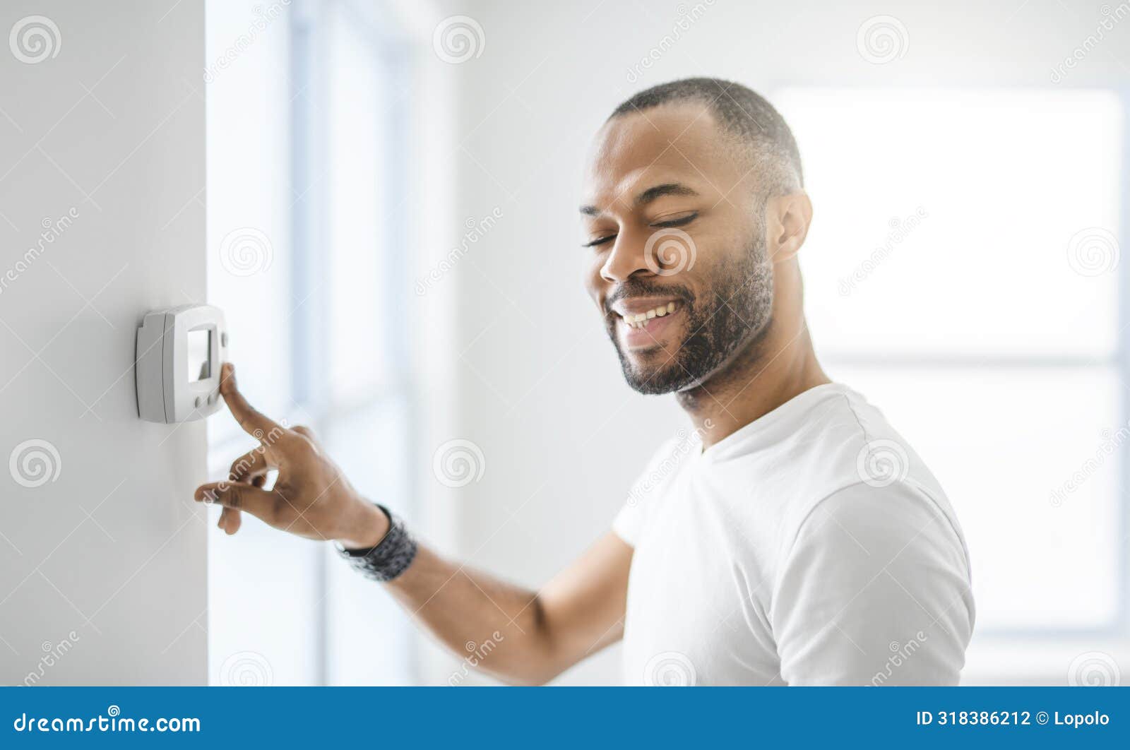 Man Choosing Temperature On Thermostat. Young Focused Guy Pushing ...
