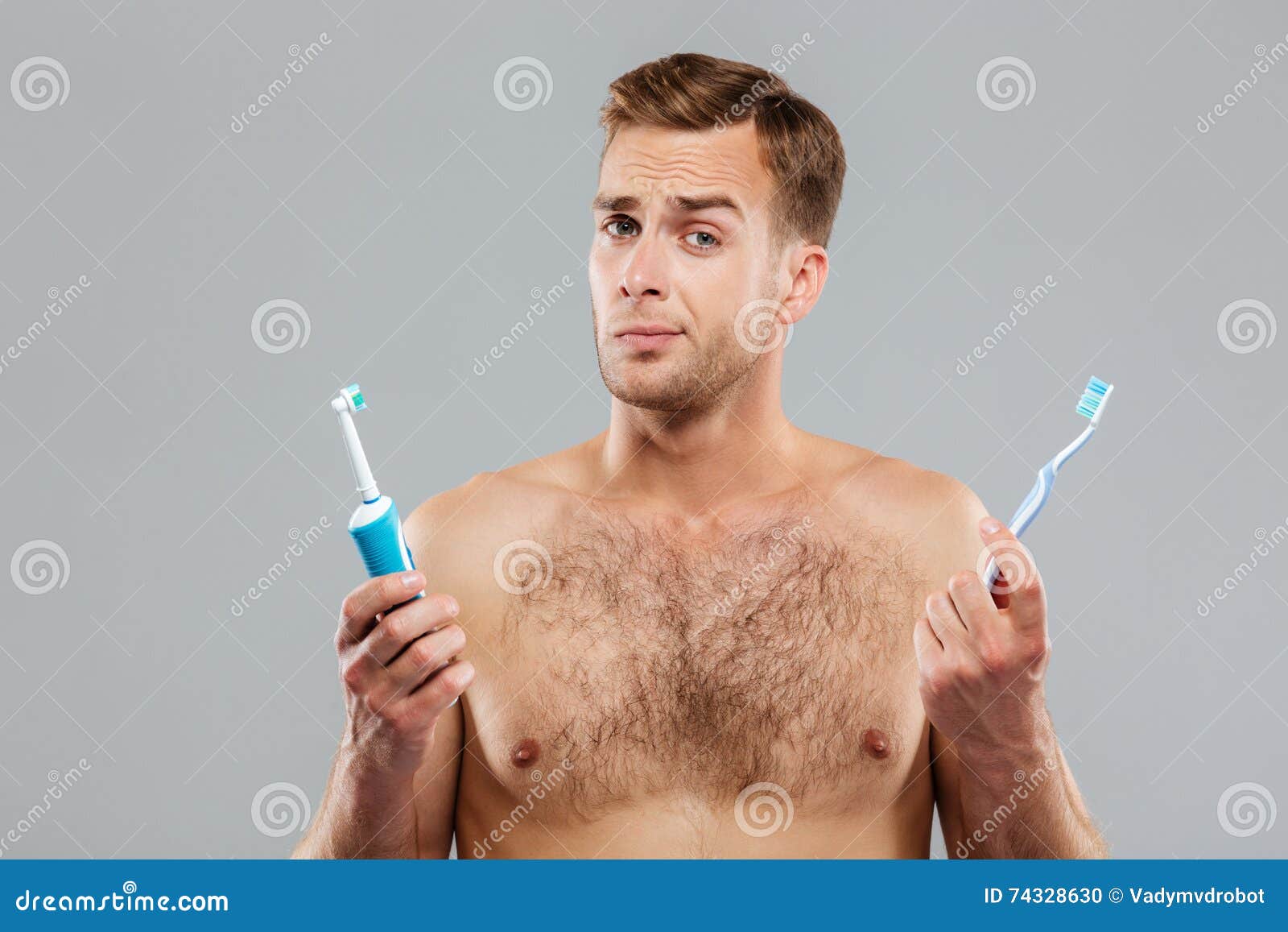 Man Choosing Toothbrush Over Gray Background Stock Photo - Image of ...