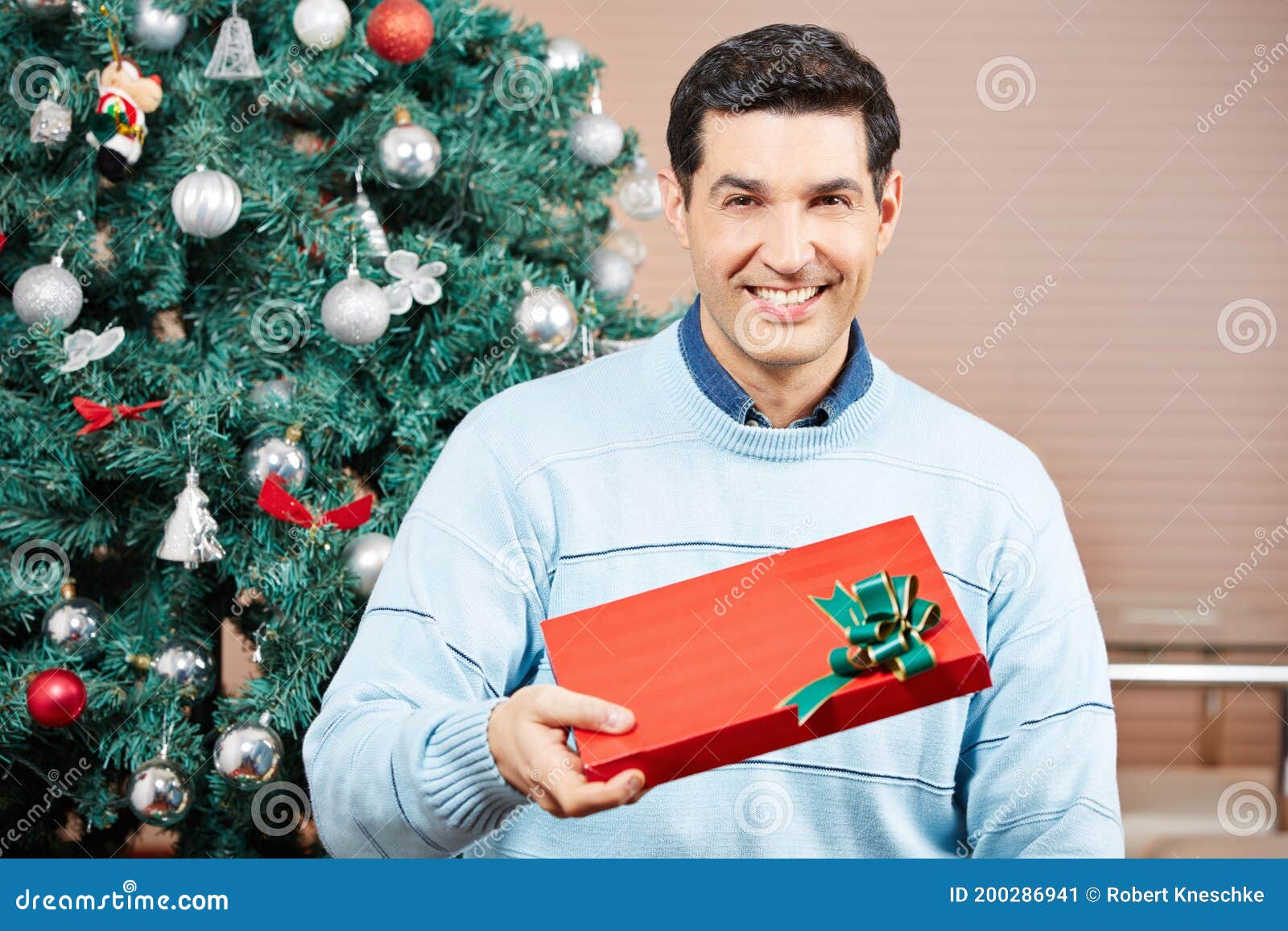 Man with Christmas present stock image. Image of celebration - 200286941