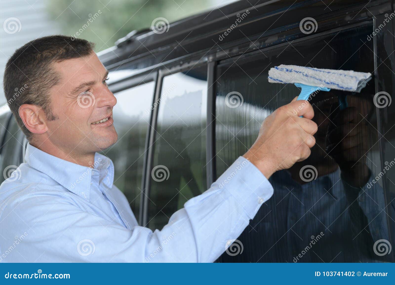 Man cleaning car window stock photo. Image of temperature - 103741402
