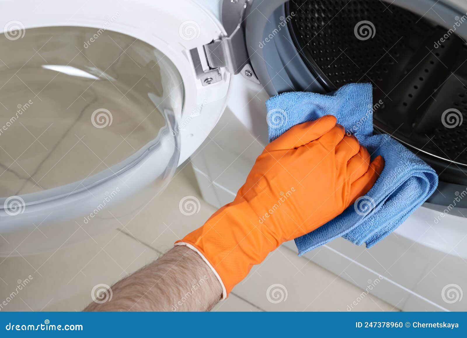 Man Cleaning Empty Washing Machine with Rag, Closeup Stock Photo ...