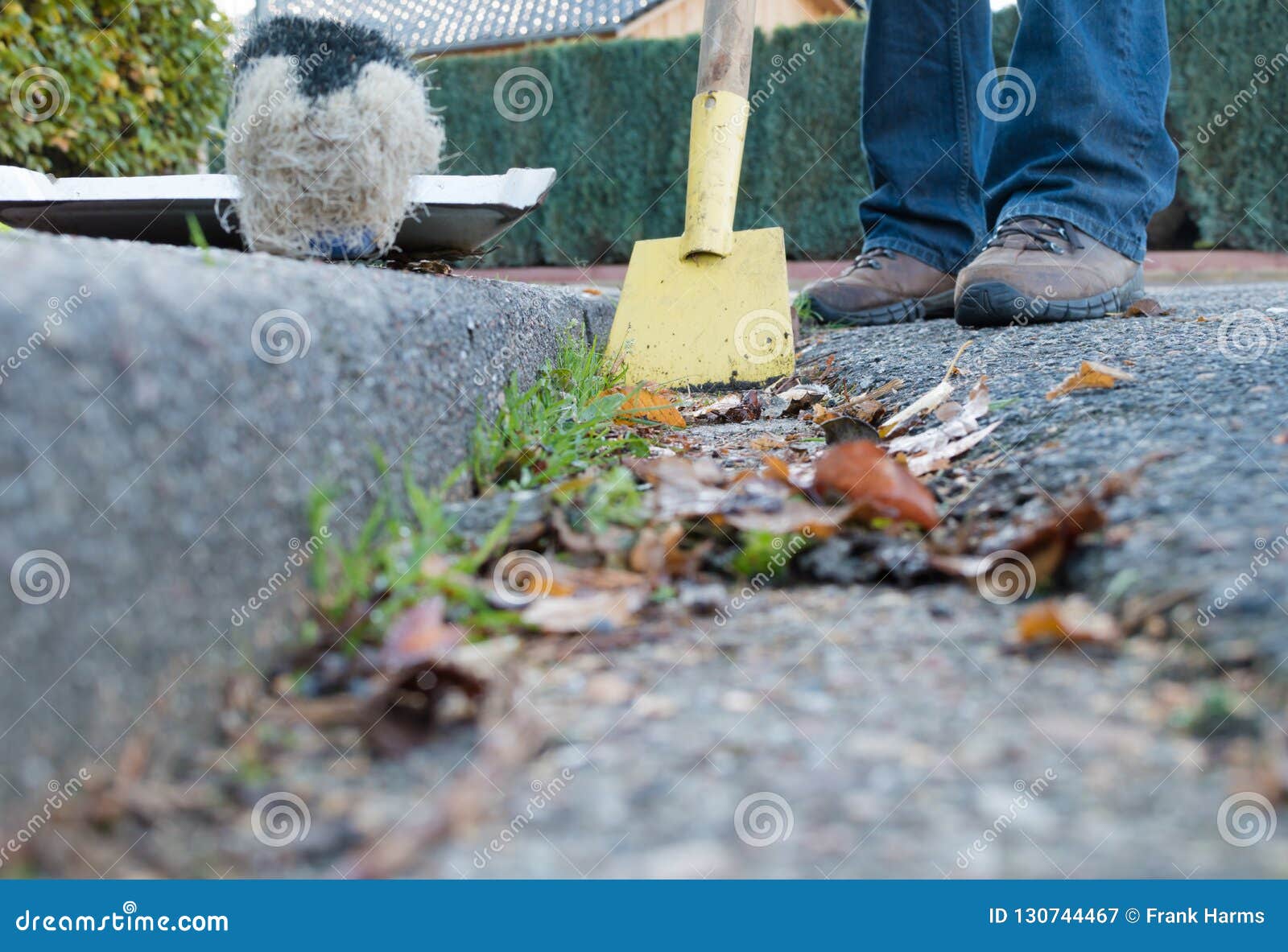 Man is cleaning the gutter stock image. Image of curbstone - 130744467