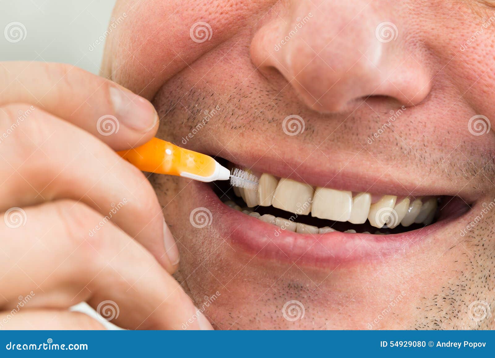 Man cleaning his teeth stock photo. Image of calculus - 54929080