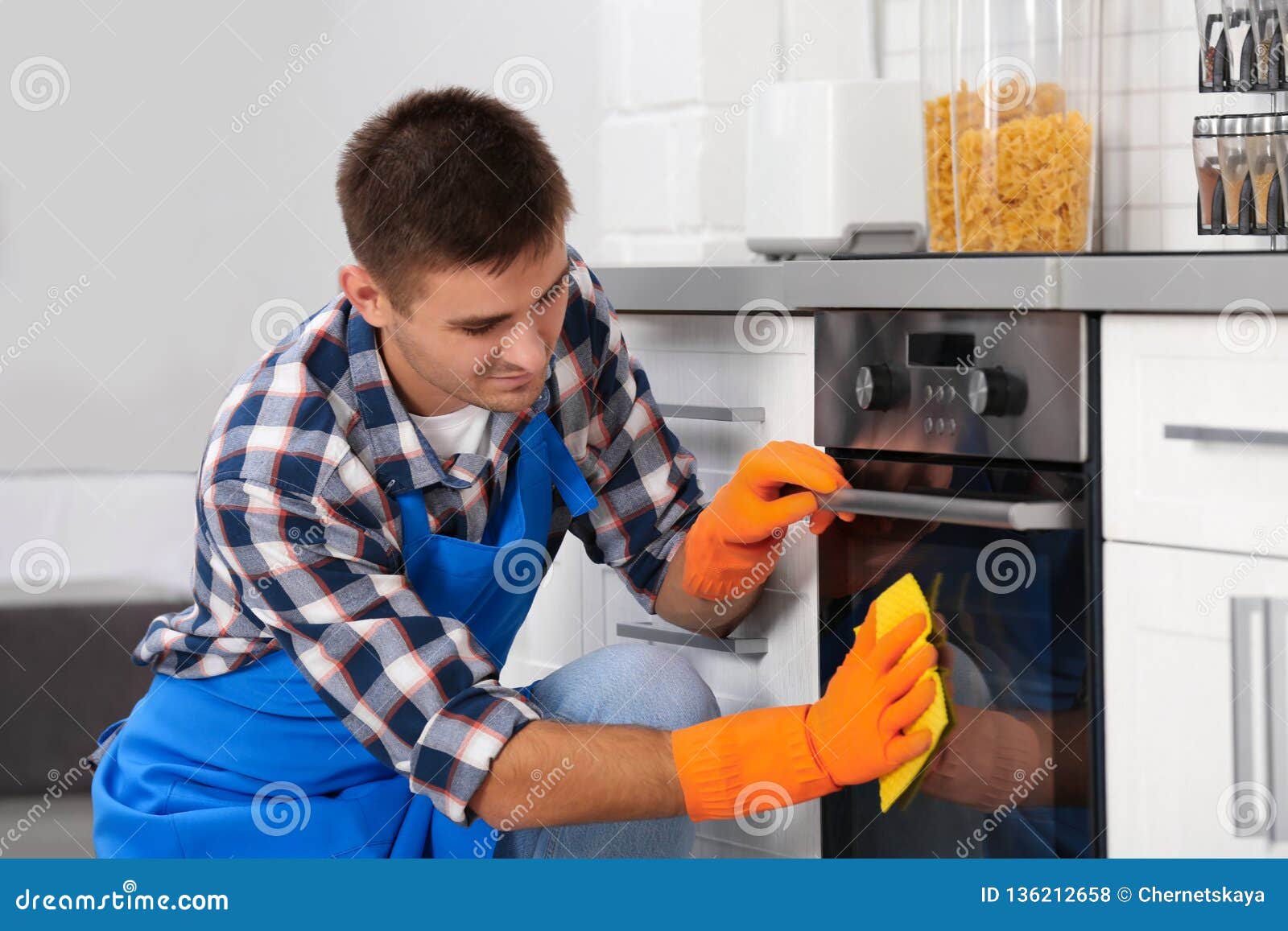 Man Cleaning Kitchen Oven with Rag Stock Photo - Image of company ...