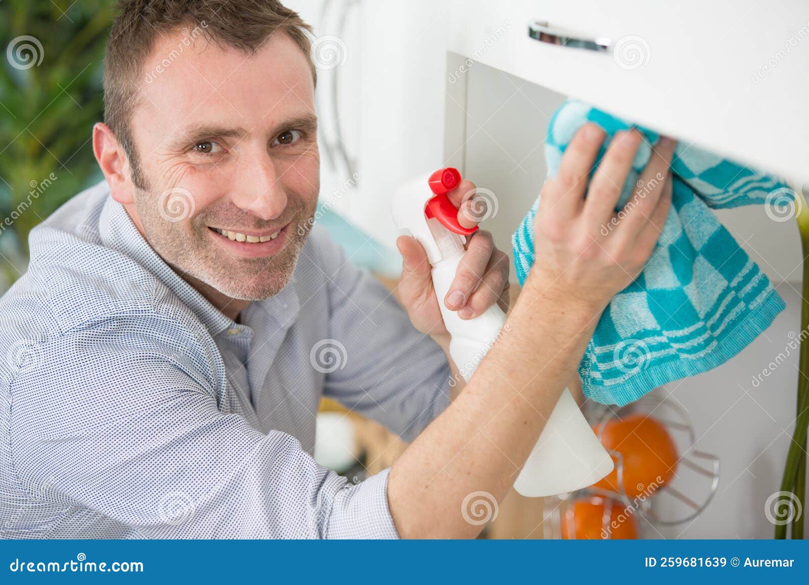 Man Cleaning Kitchen Using Spray Detergent Stock Image - Image of ...