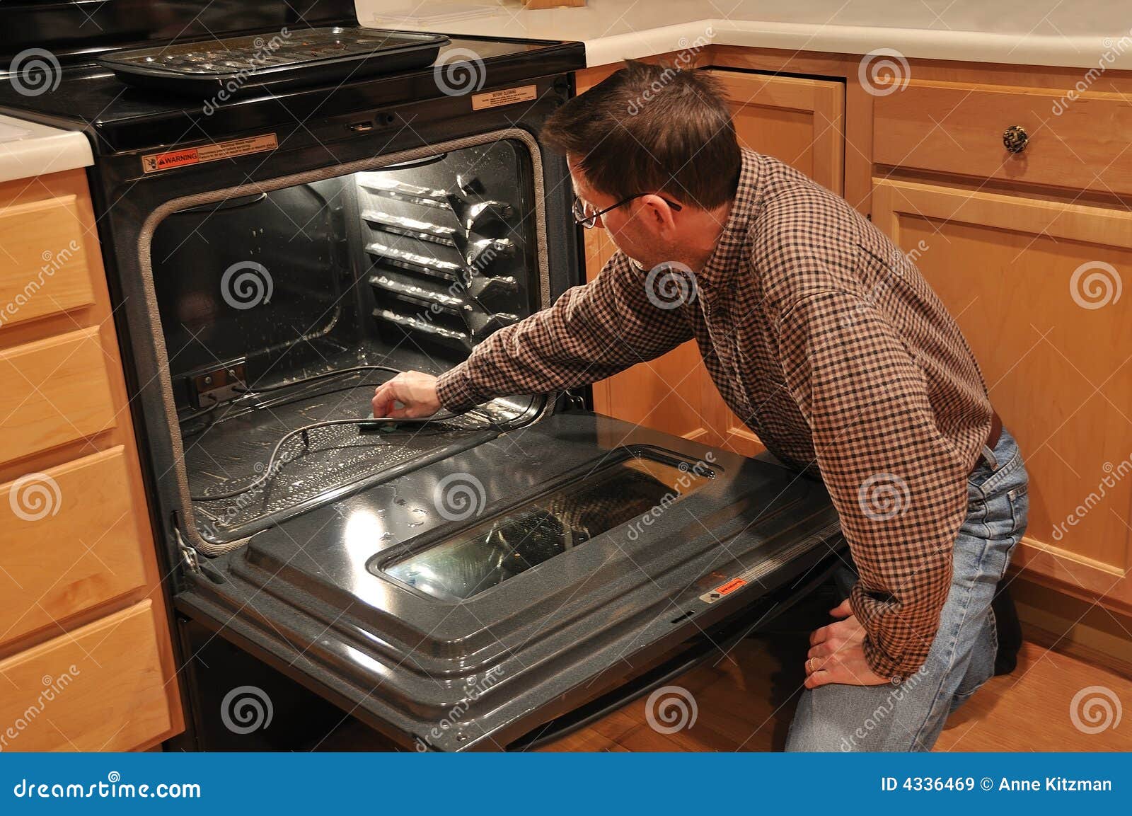 Man Cleaning an Oven stock image. Image of husband, oven - 4336469
