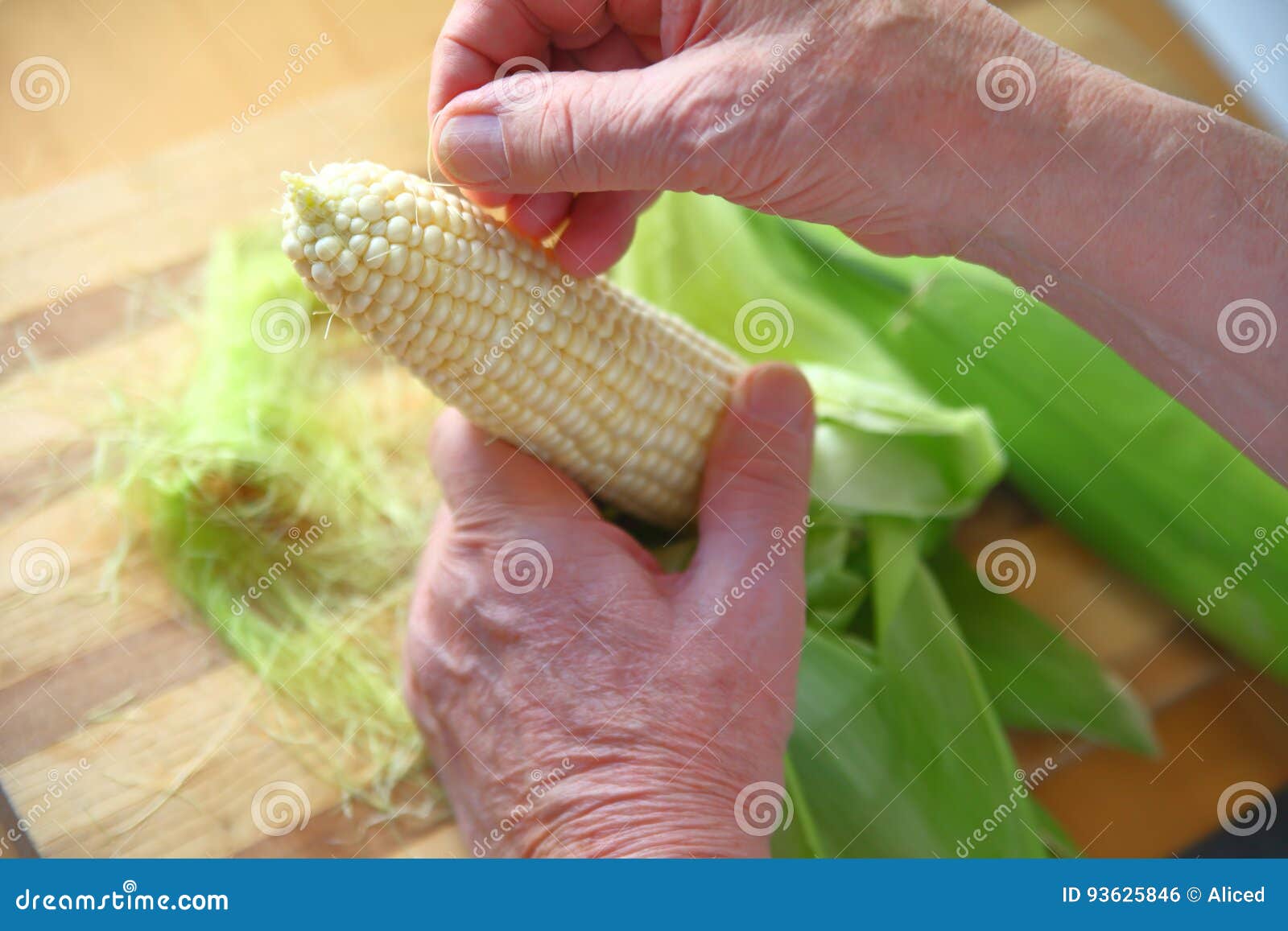 Man Cleaning Silks Off Fresh Corn Stock Photo - Image of holding, fresh ...