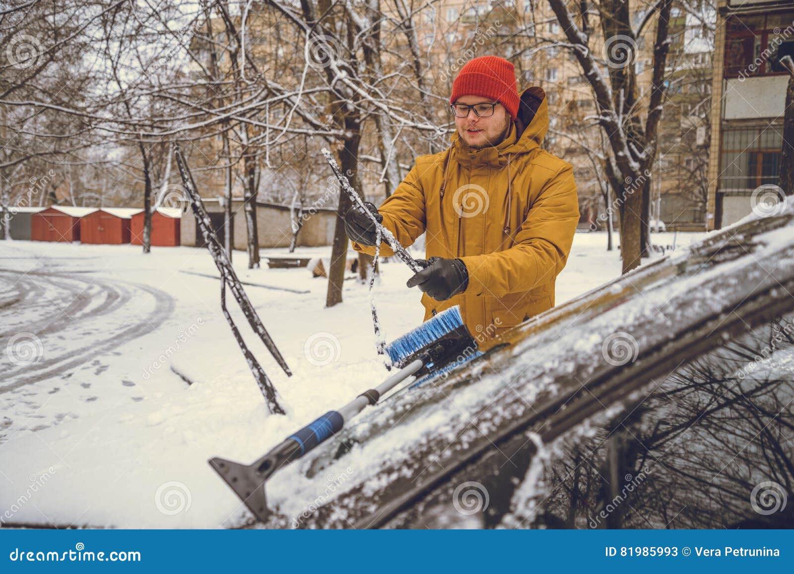 Man Cleaning Snow from Car Windshield with Brush Stock Image - Image of ...