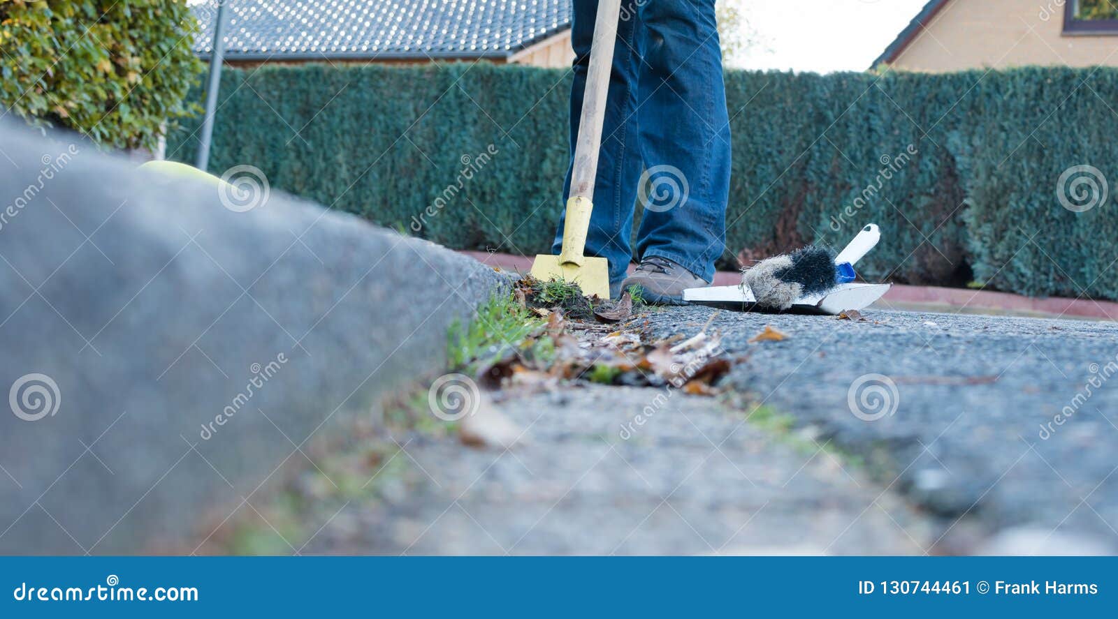 Man is cleaning the gutter stock image. Image of curb - 130744461