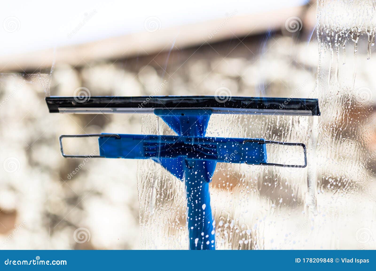 Man Cleaning Window Using Window Cleaning Squeegee and Cleaning Sprayer ...