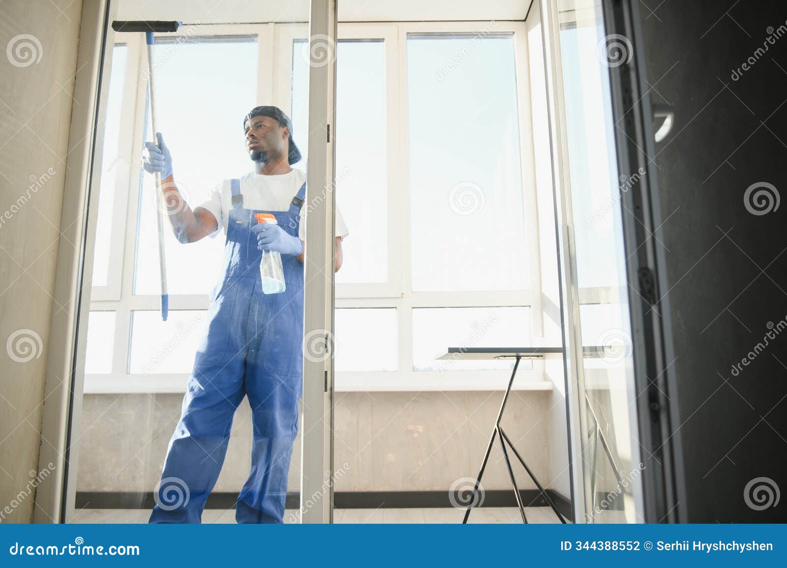 A Man Cleaning Windows. Men Washes the Windows Stock Photo - Image of ...