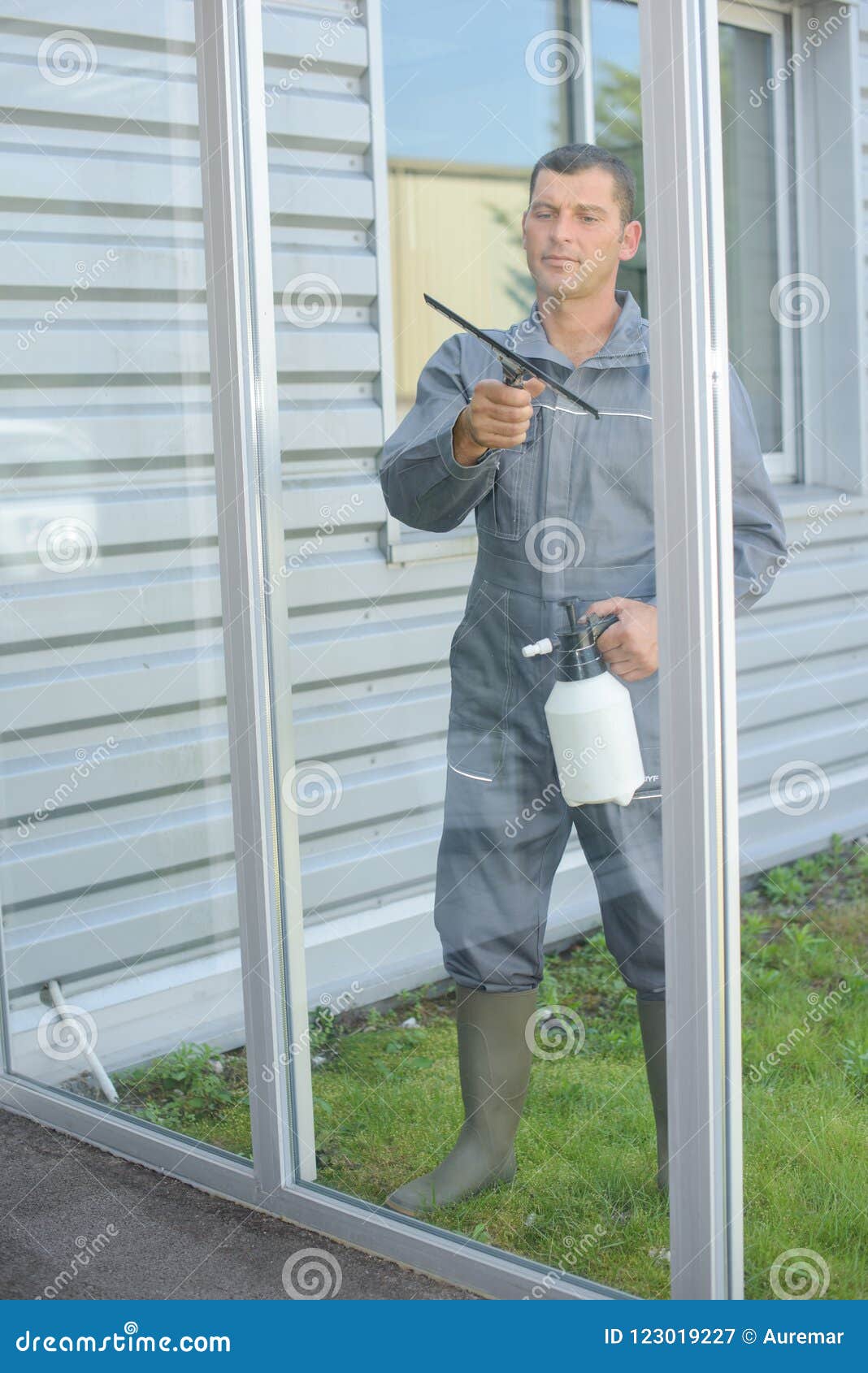 Man Cleaning Windows with Squeegee Stock Image - Image of human, spray ...