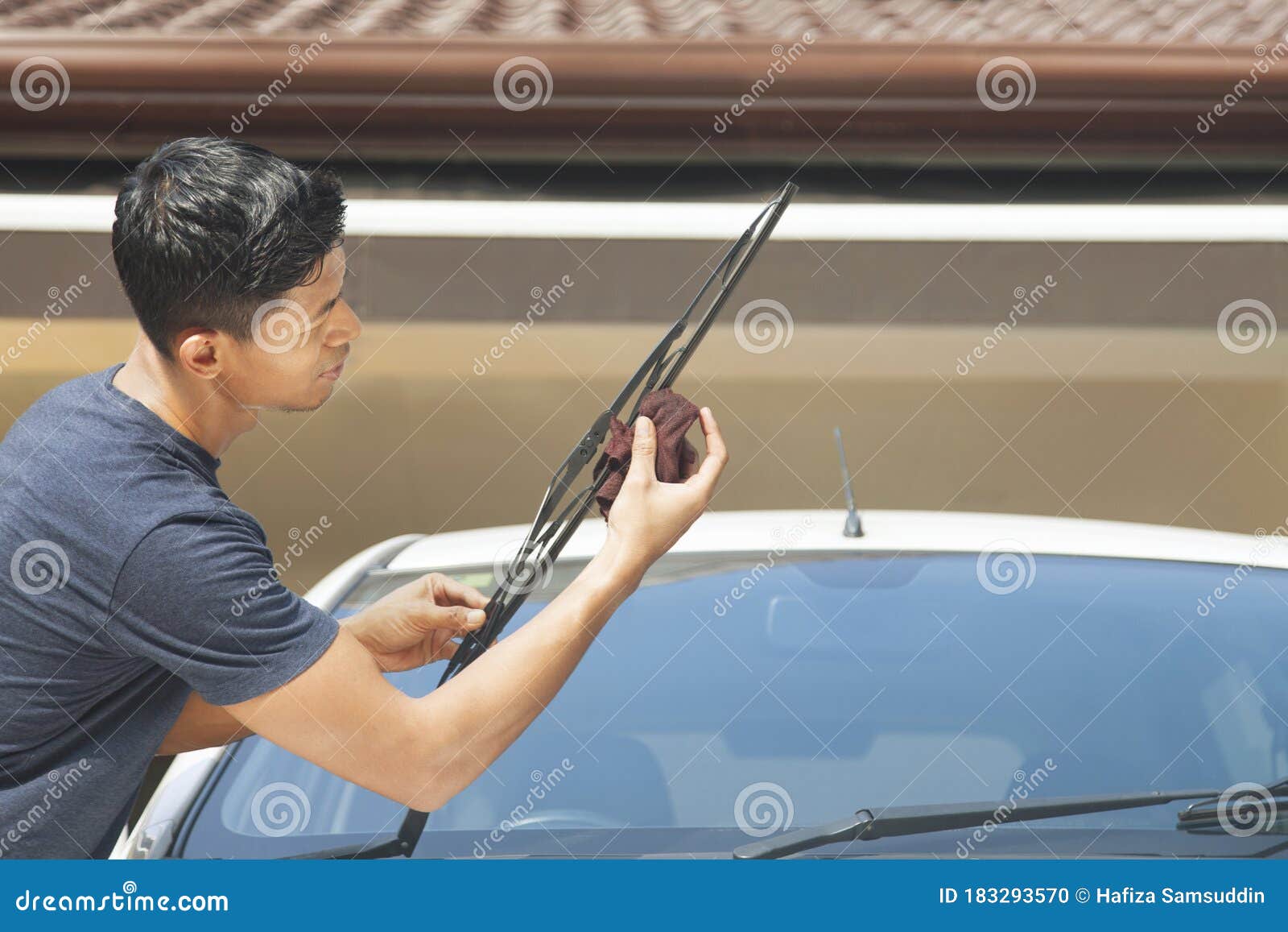 Man Cleaning Windshield Wiper of His Car Stock Photo - Image of ...