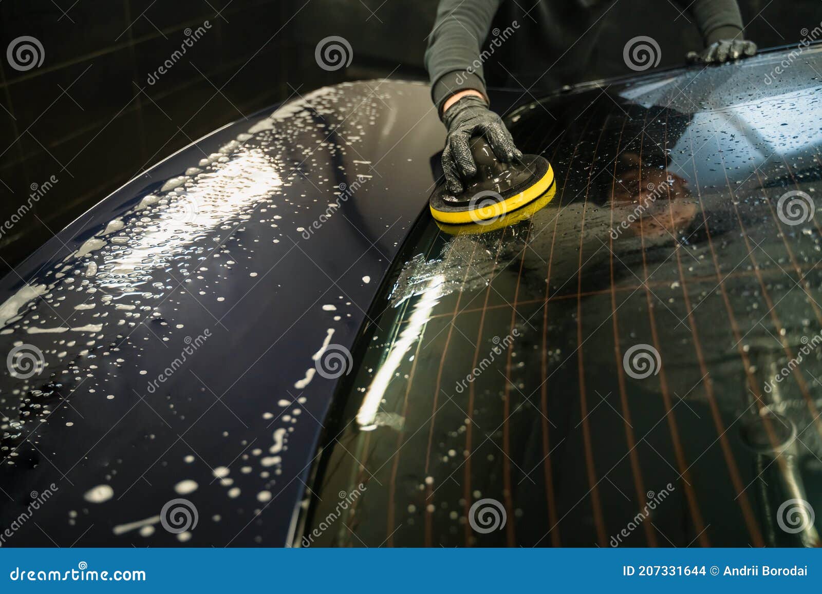 Man Cleans Rear Window of Car with Circle Sponge. Professional Car Wash ...