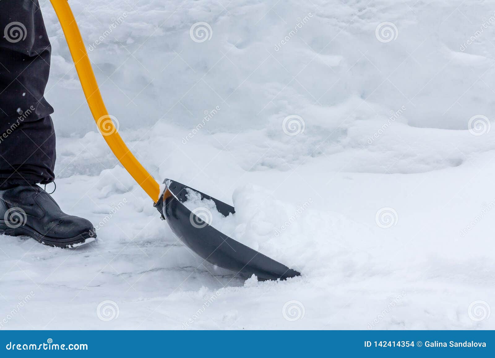 A Man Cleans Snow in the Yard with a Shovel after a Heavy Snowfall ...