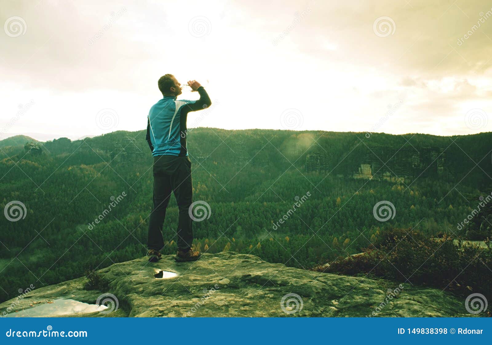 Man on a Cliff Edge on Top of Mountain with Gorgeous View Stock Photo ...
