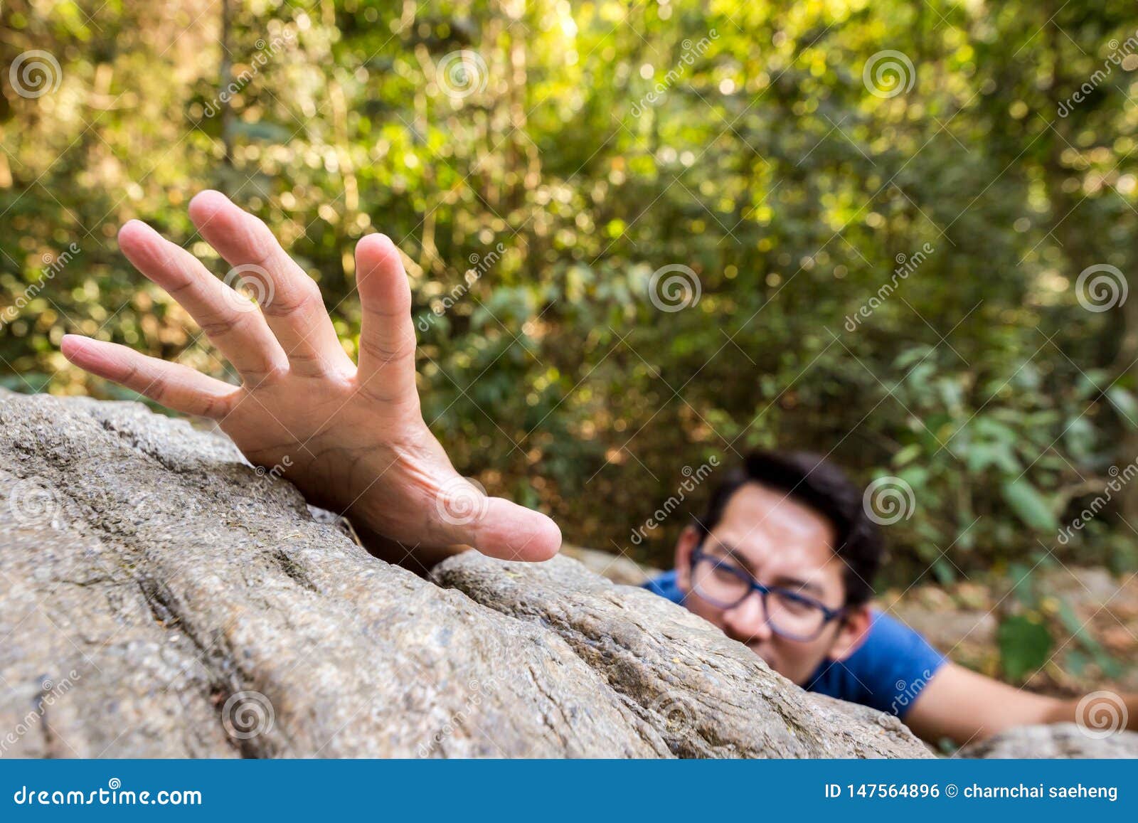 Man Climb Rock in the Forest and Hand for Help Stock Photo - Image of ...