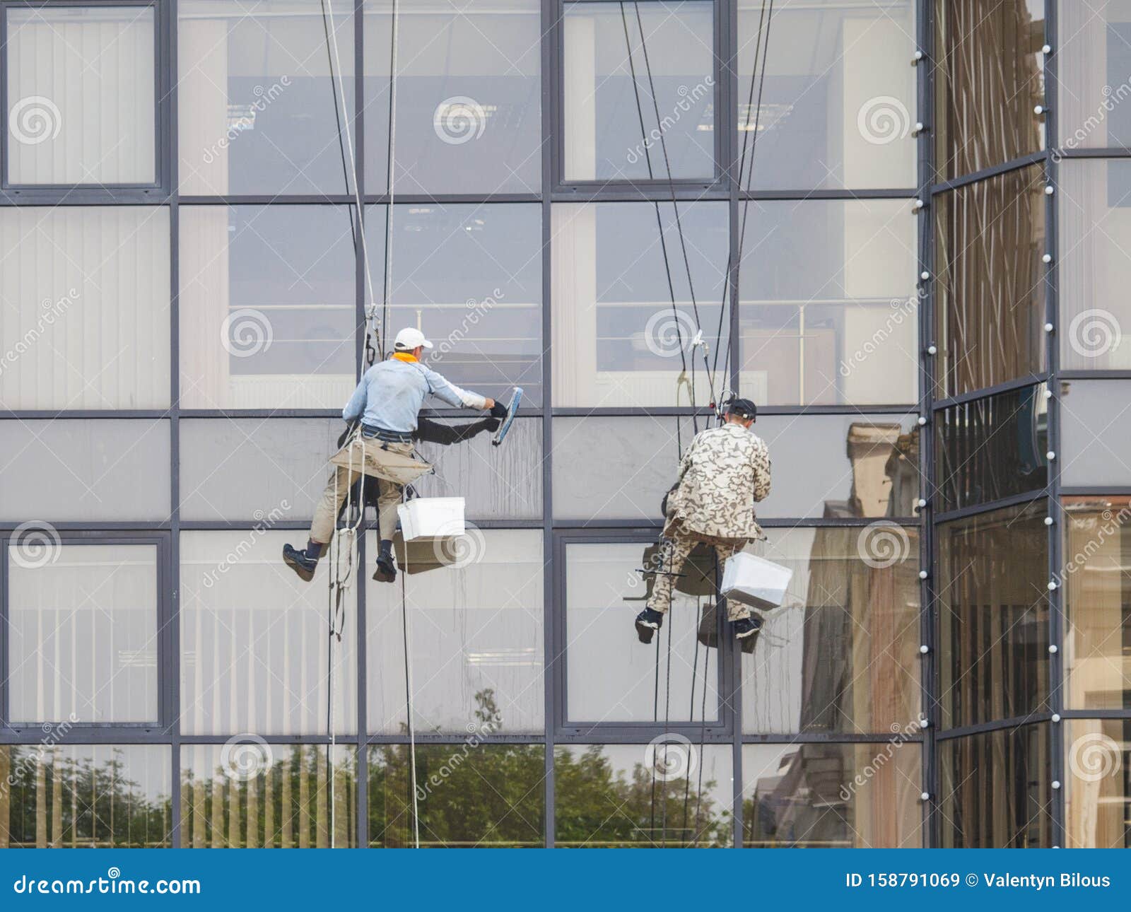 A Man at High Altitude with Insurance Washes a Window Editorial Stock ...
