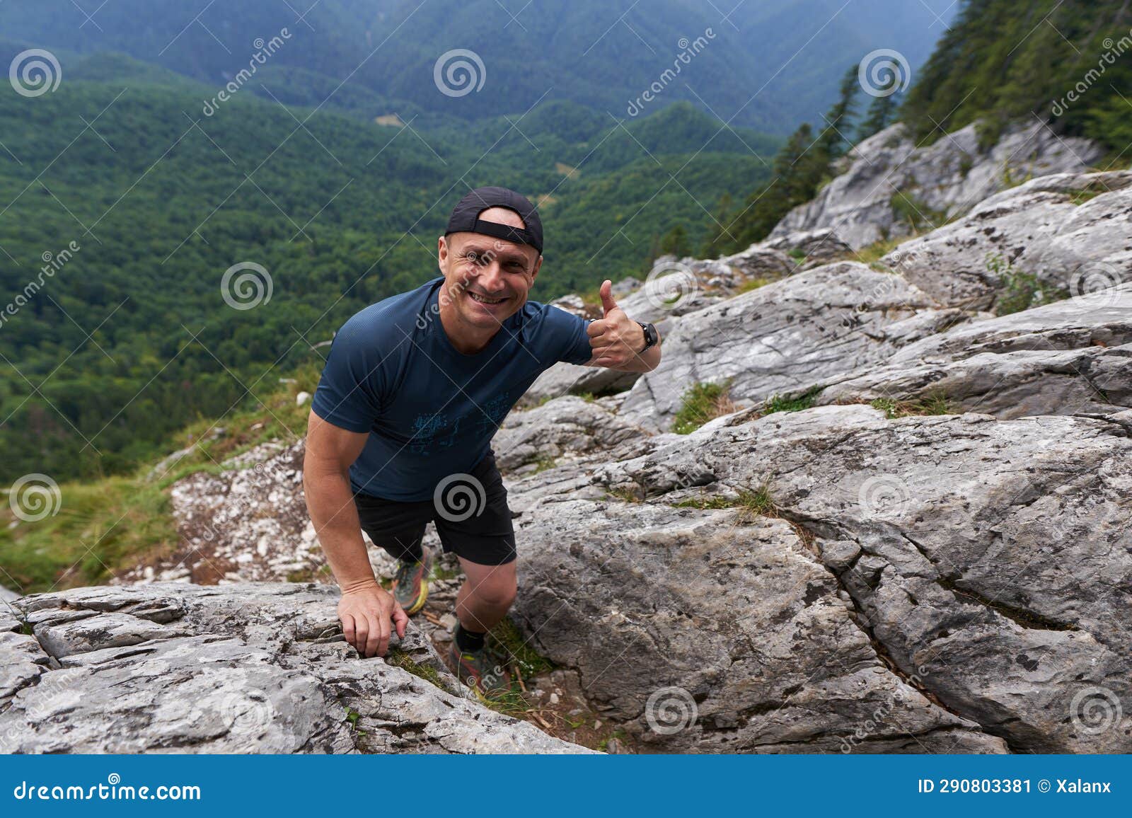 Man climbing rock face stock image. Image of boulder - 290803381