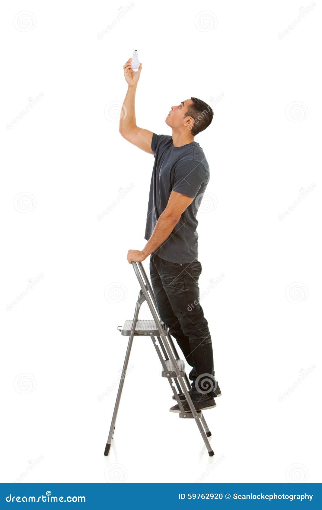 Man Climbing Stepladder To Replace Light Bulb Stock Photo - Image of ...