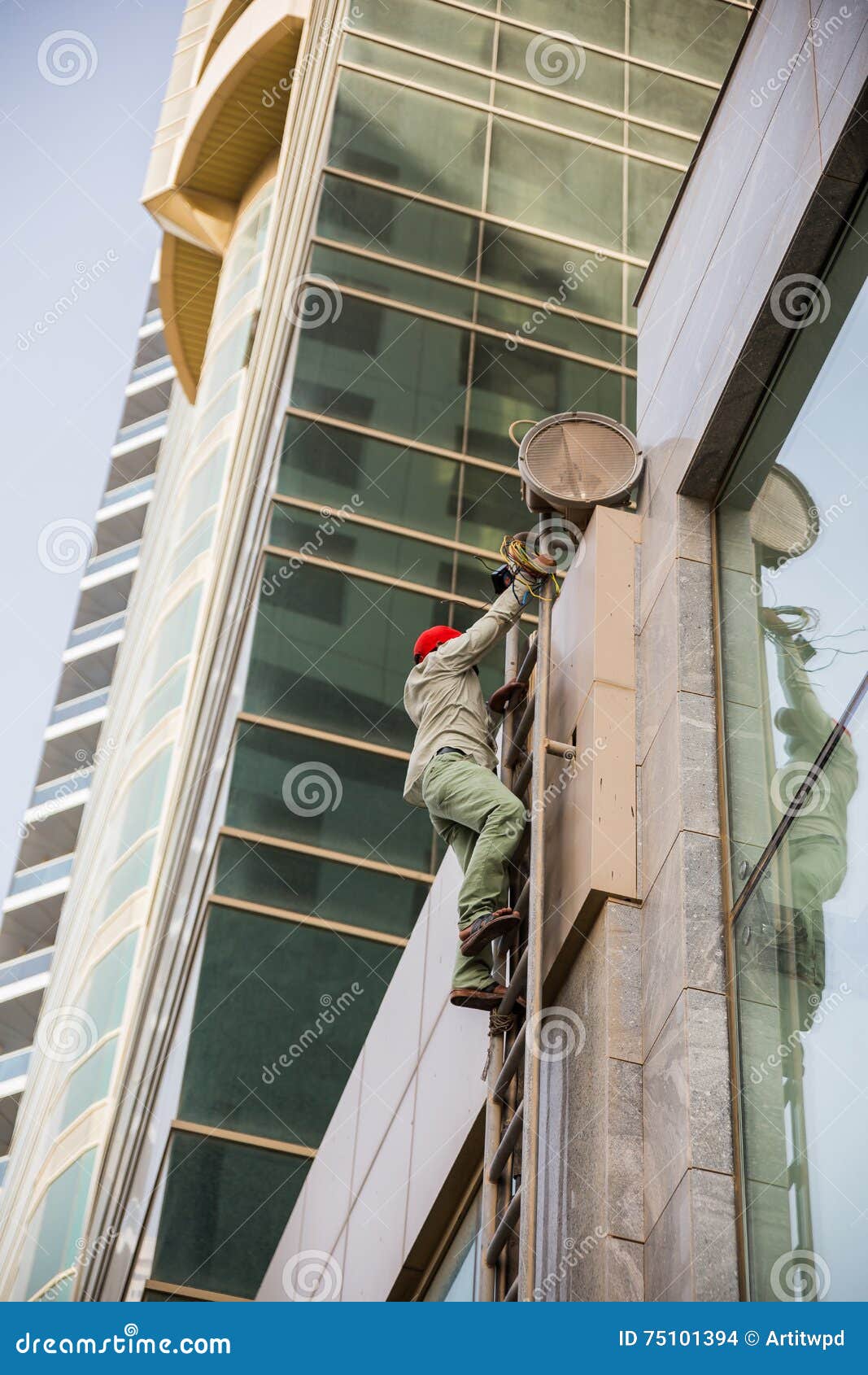 Man Climbing To the Top of the Building for Services at Dubai Stock ...