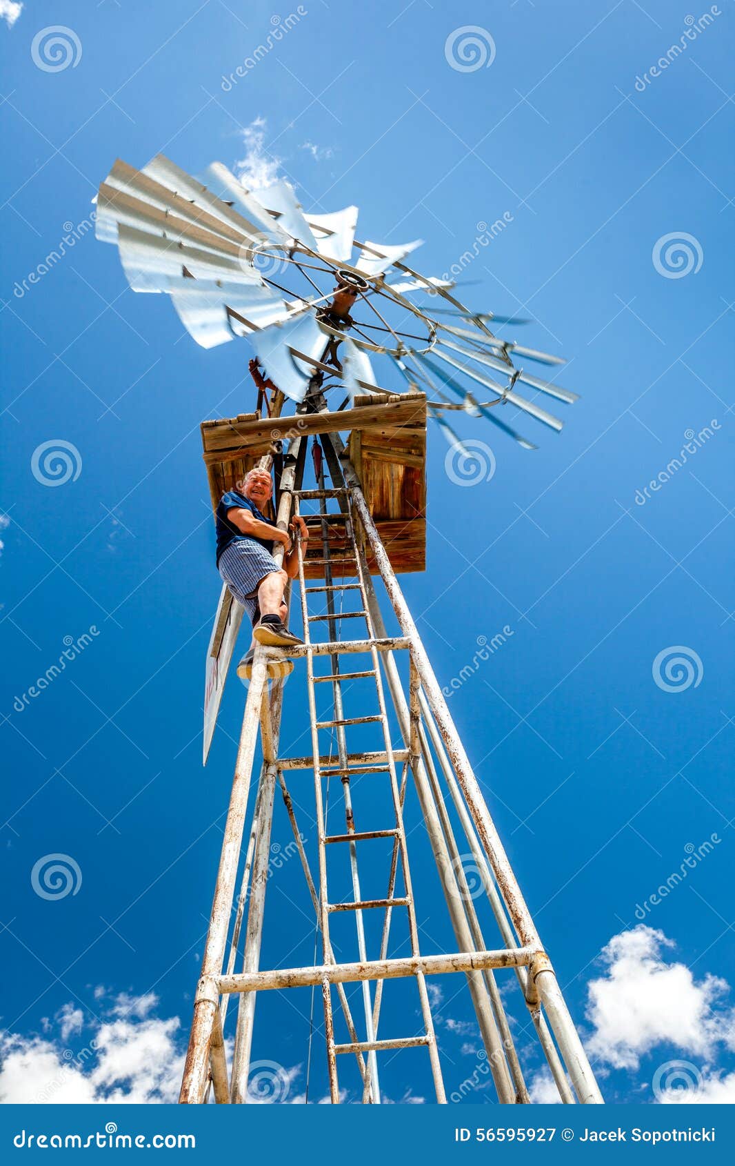 Man climbing a windmill stock image. Image of abstract - 56595927