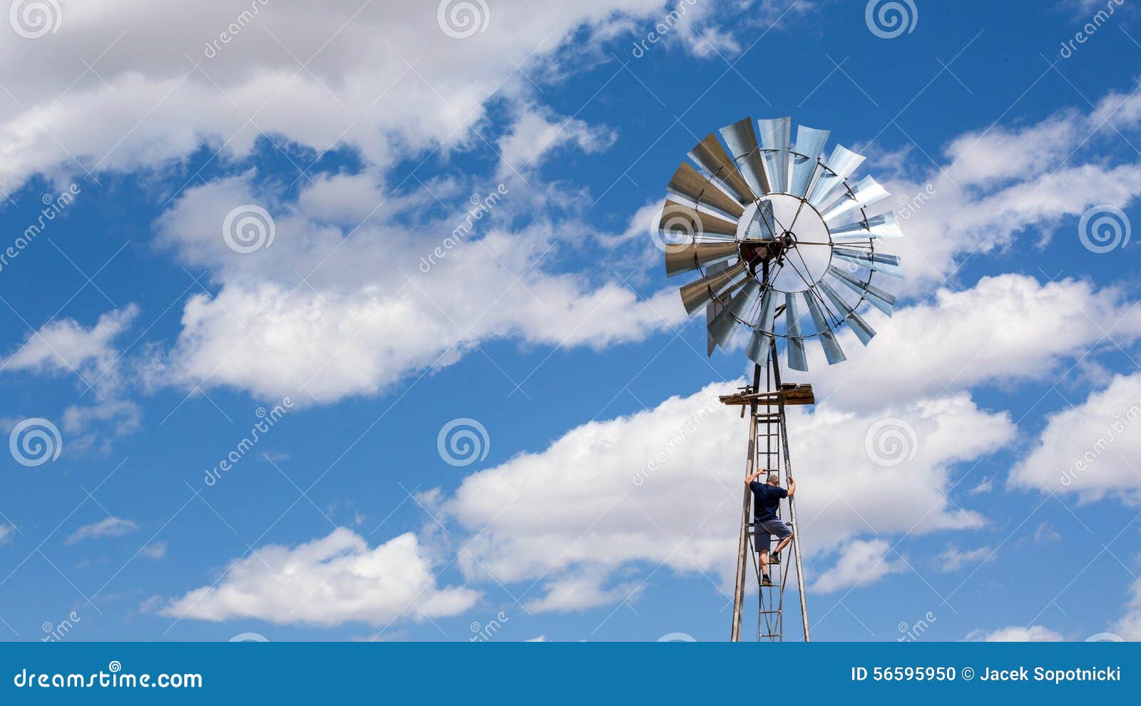 Man climbing a windmill stock photo. Image of american - 56595950