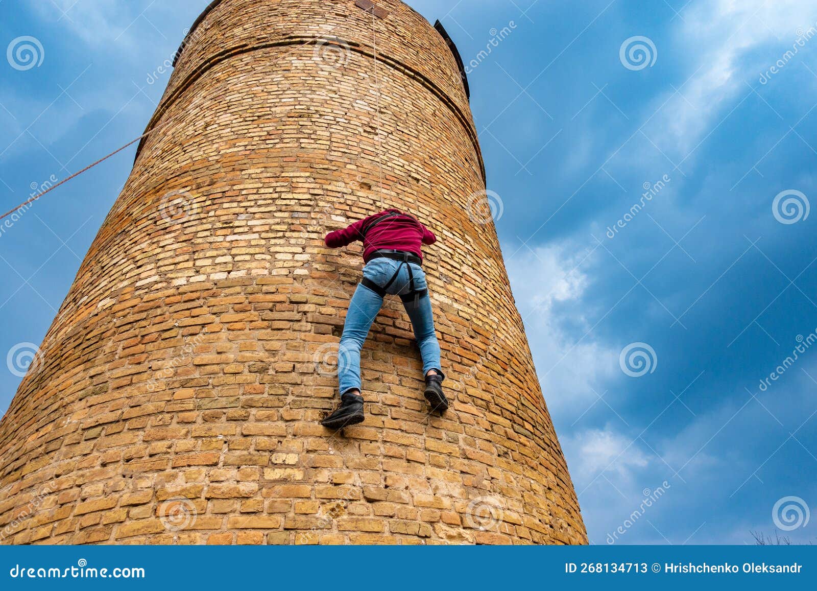 A Man Climbs Up a Tower with a Rope Stock Image - Image of ...