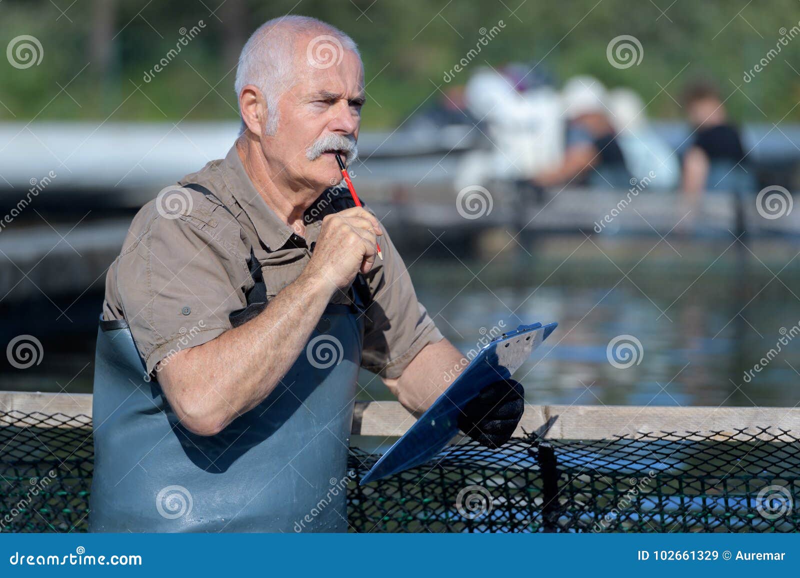 Man with Clipboard Standing by River Writing Something Stock Image ...