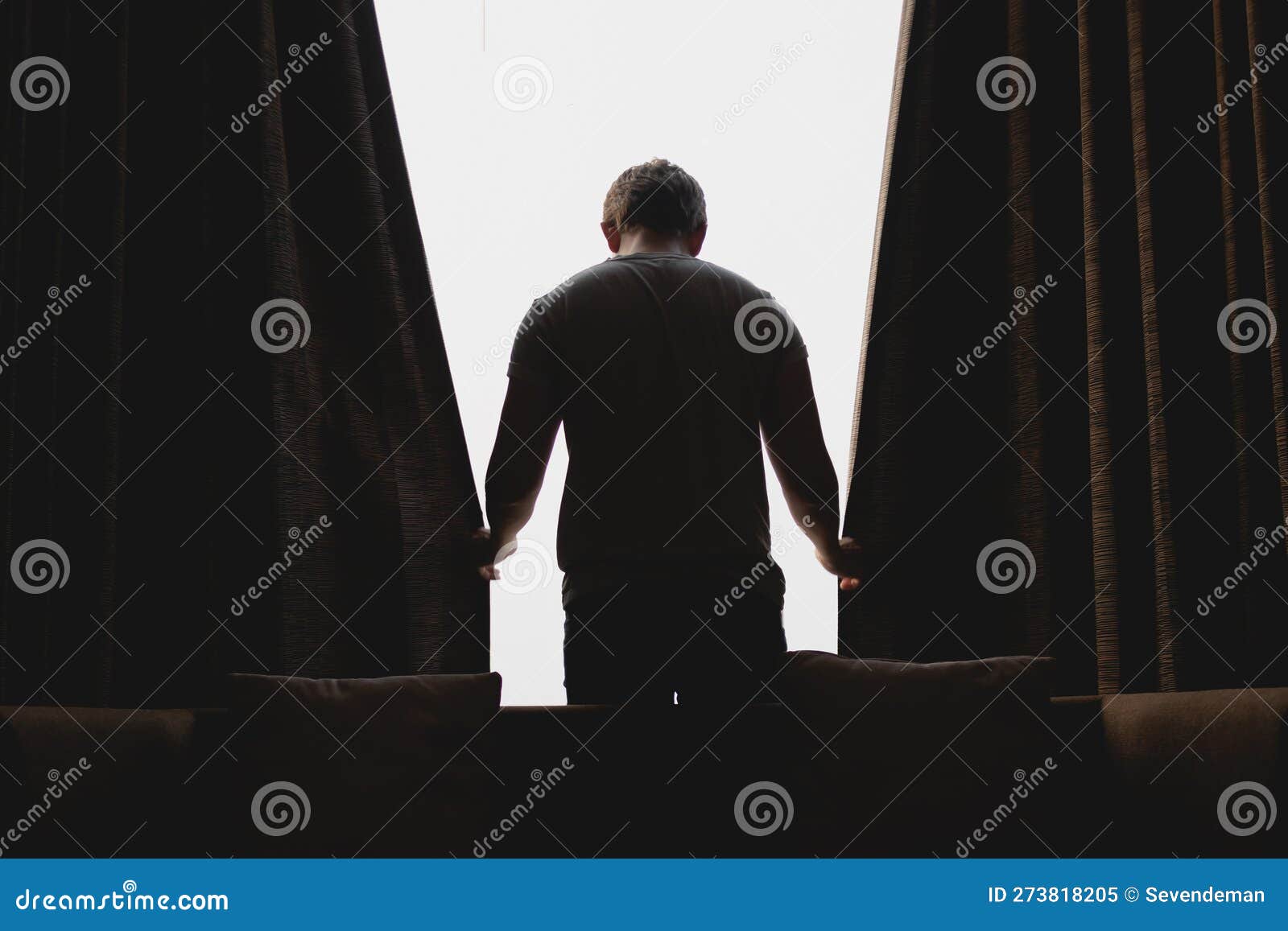 Man Closing the Curtain while Watching the View Out of the Window ...