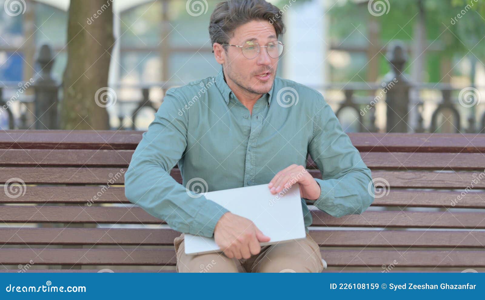 Man Closing Laptop Going Away from Bench Stock Image - Image of modern ...