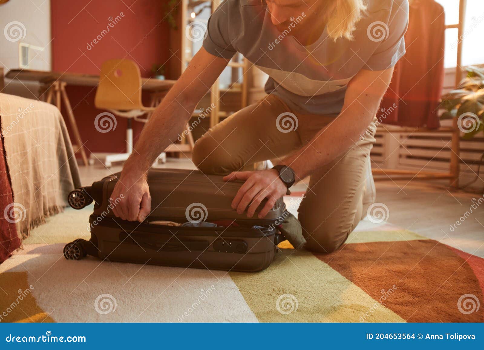 Man closing the suitcase stock photo. Image of vacations - 204653564