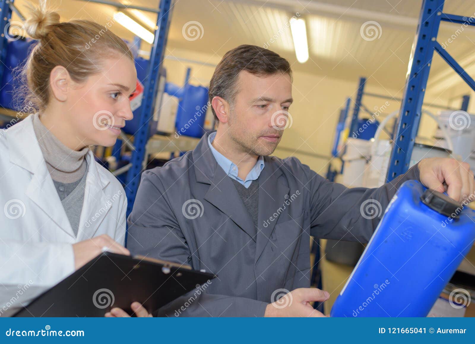 Man and Co-worker Examining Air Compressor in Hardware Store Stock ...